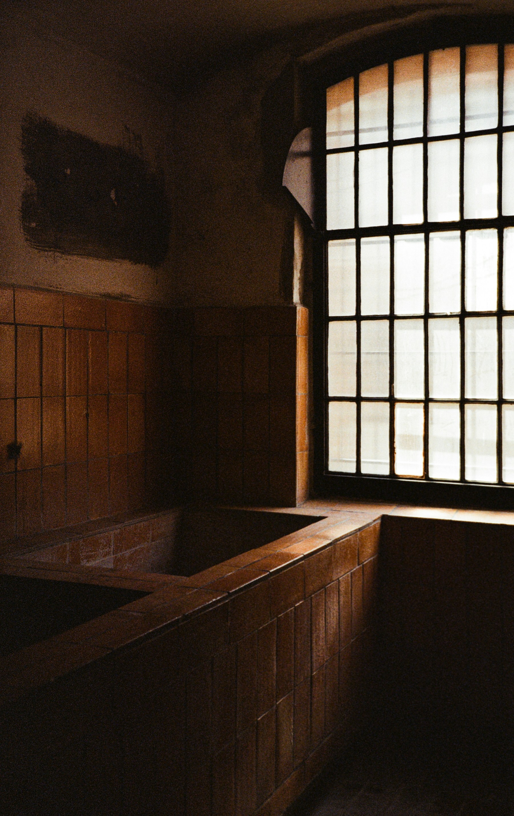 Gloomy room with window and barred windows.