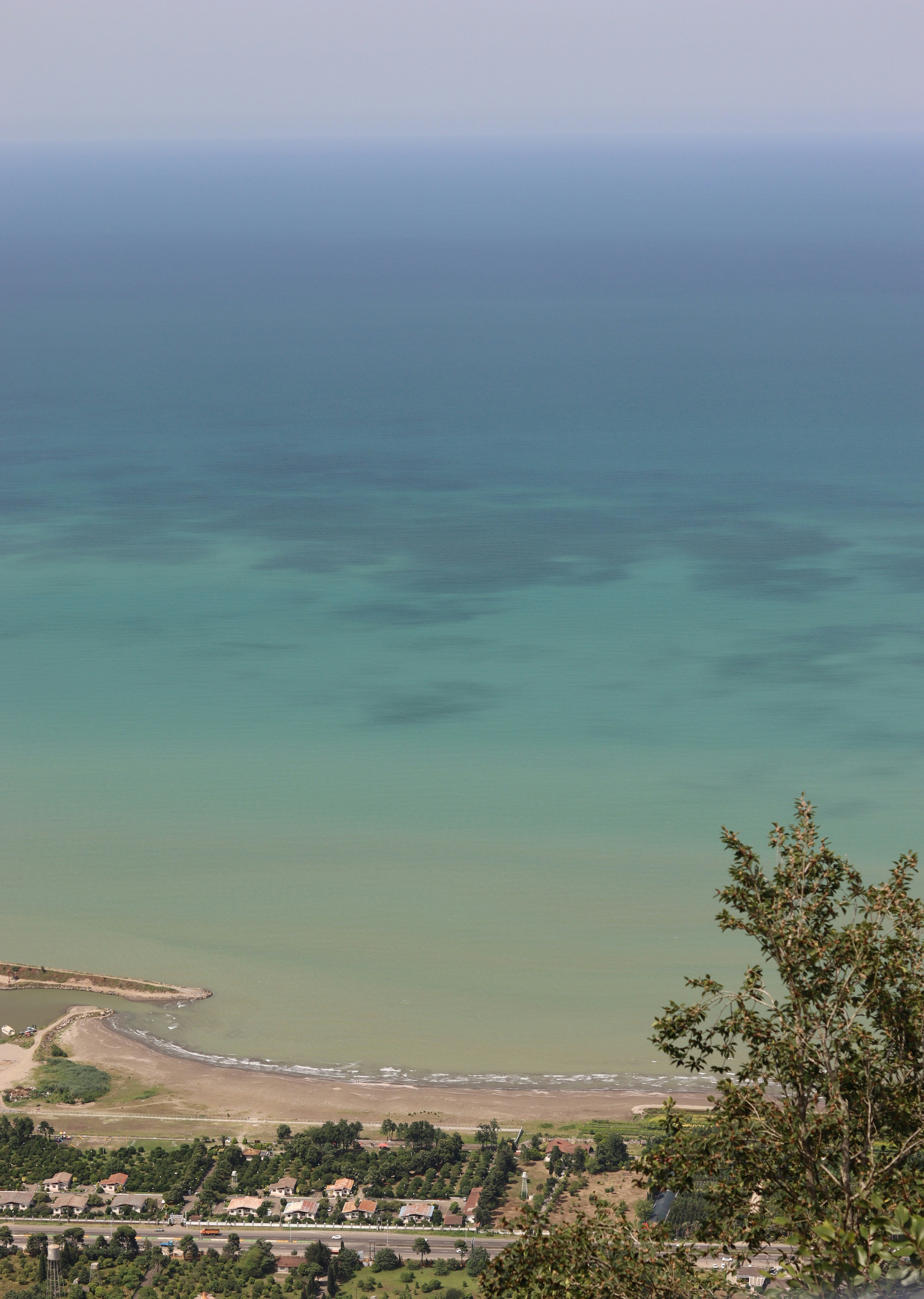Beautiful coastal view with water and trees.