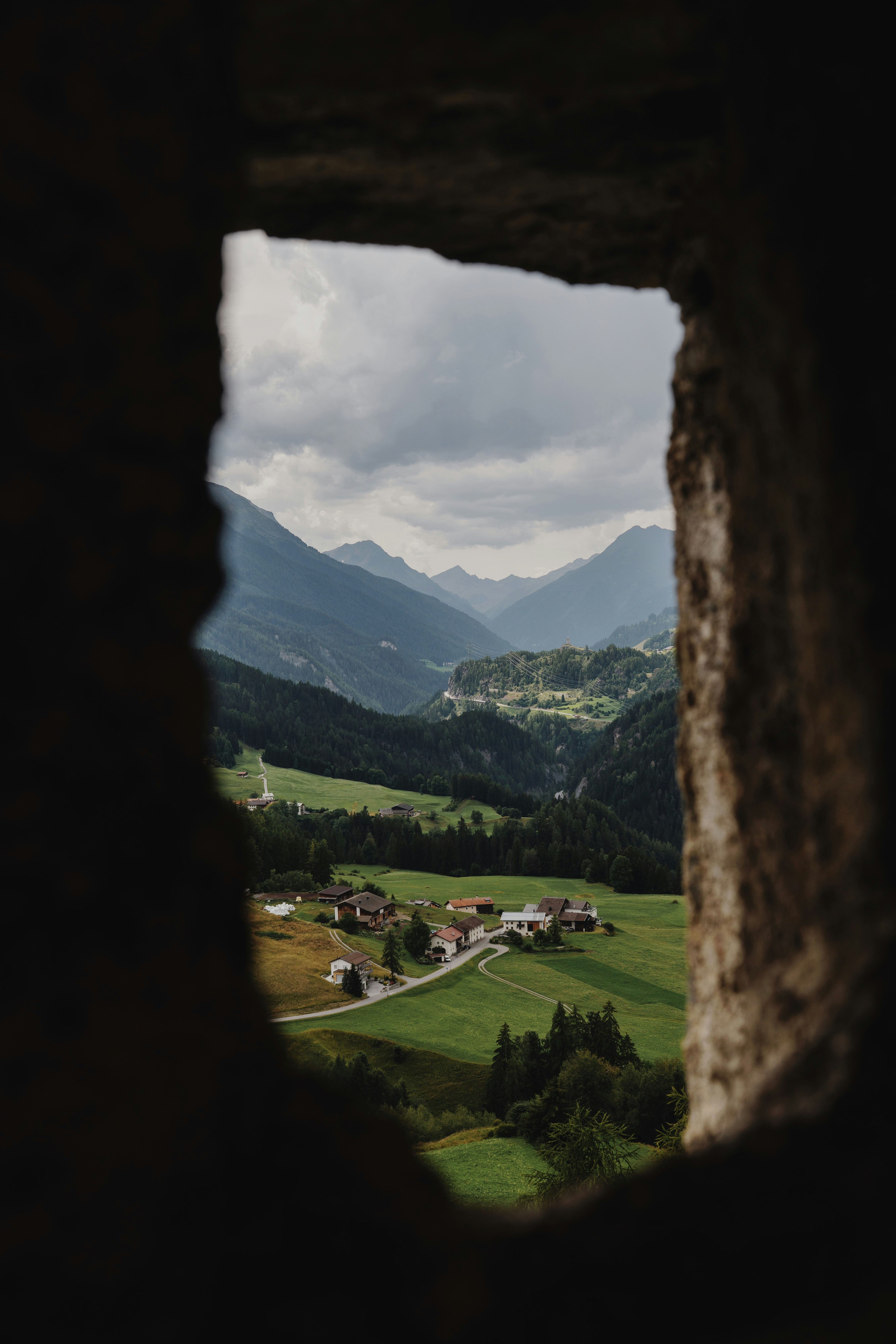 Mountainous landscape framed by a window.