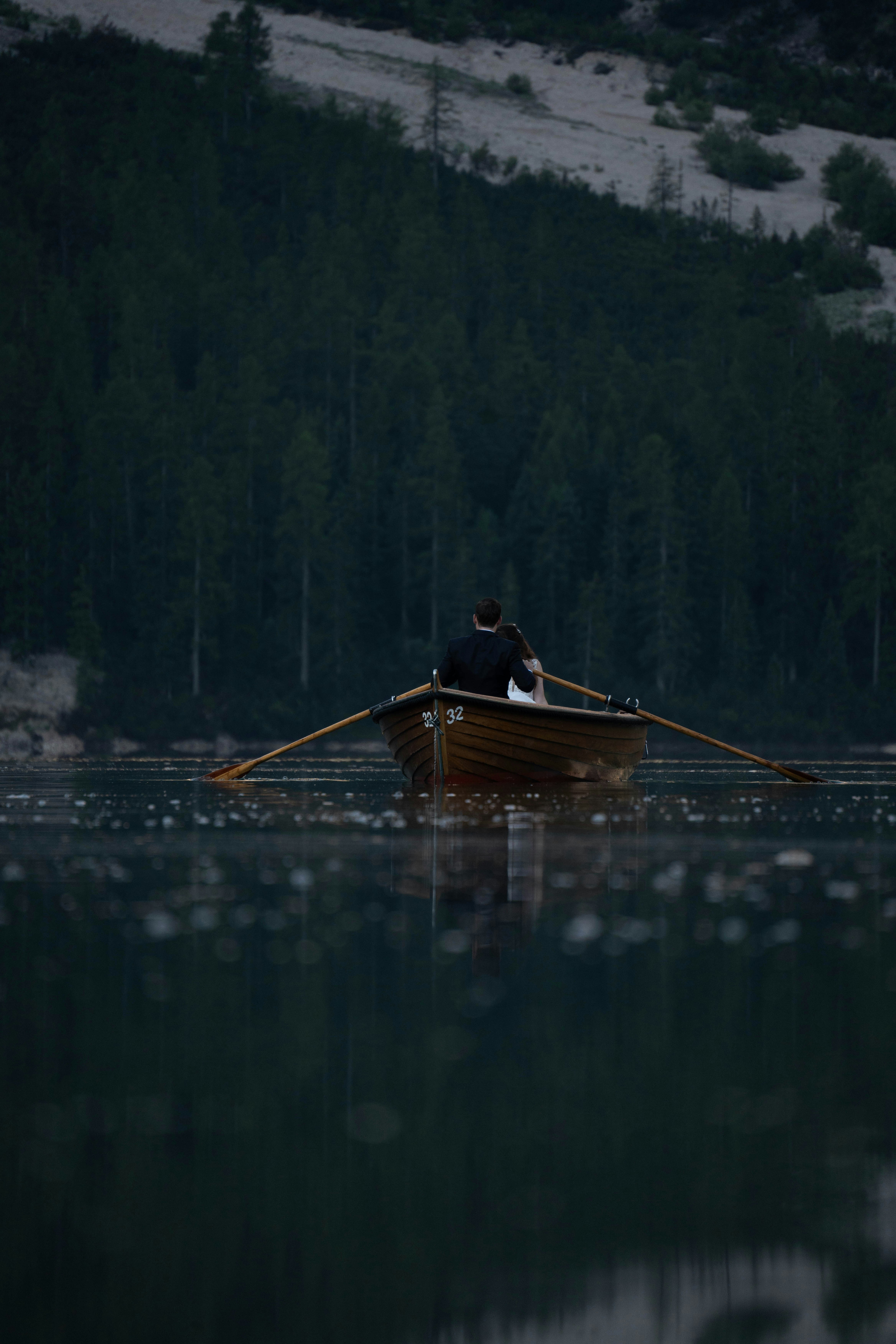 Two people are rowing a boat on the water.