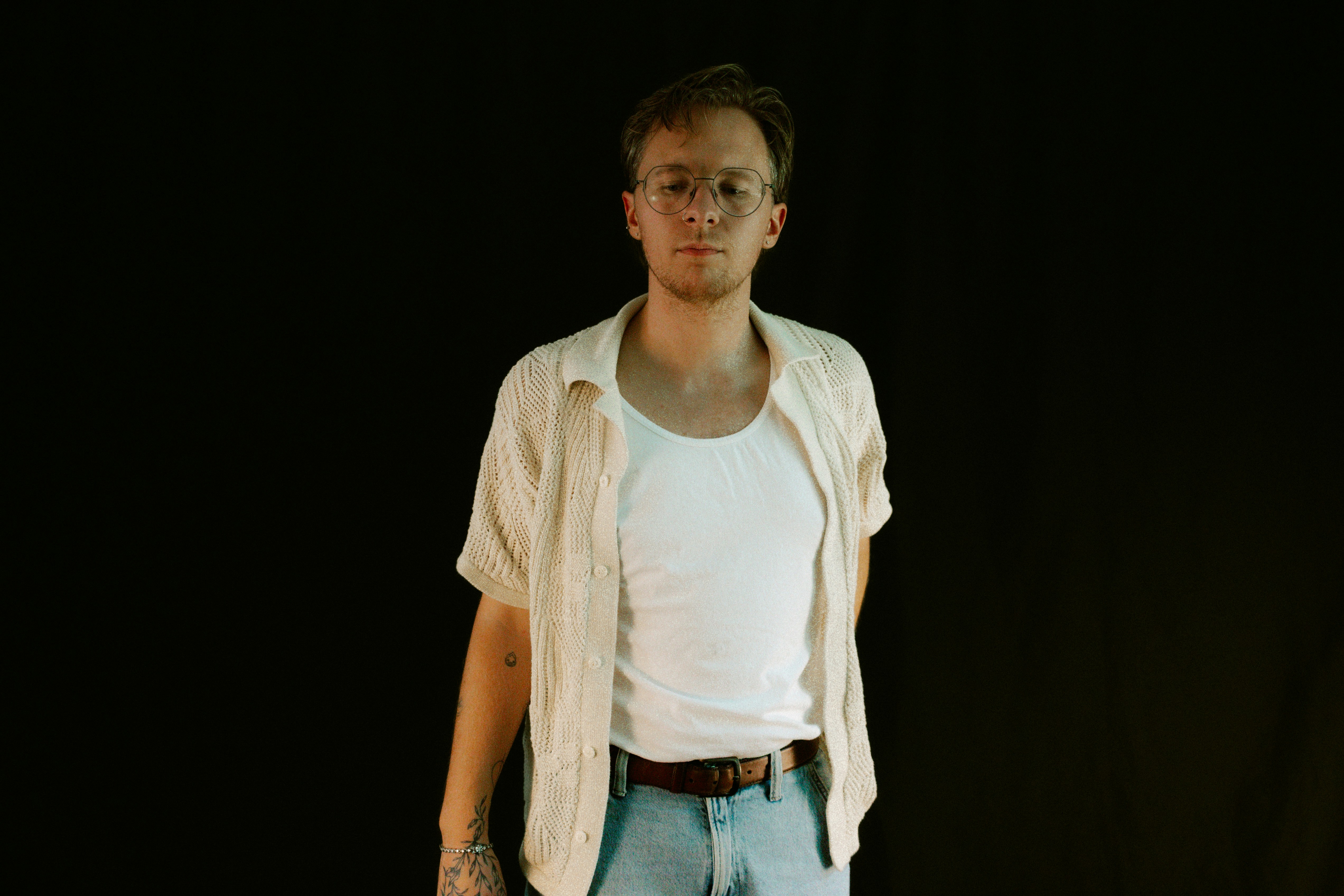 A man stands against a black background.