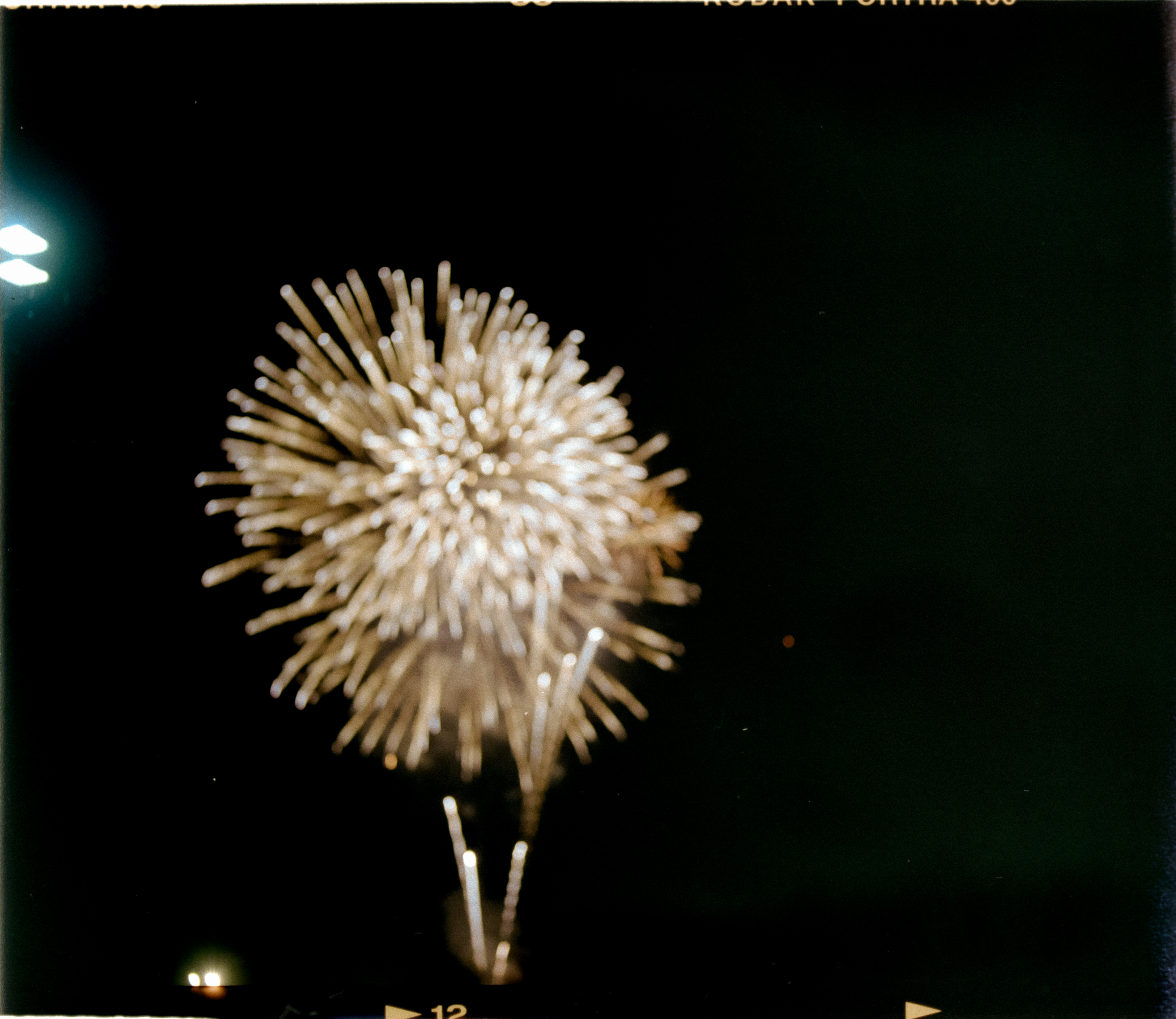 Fireworks explode in the night sky.