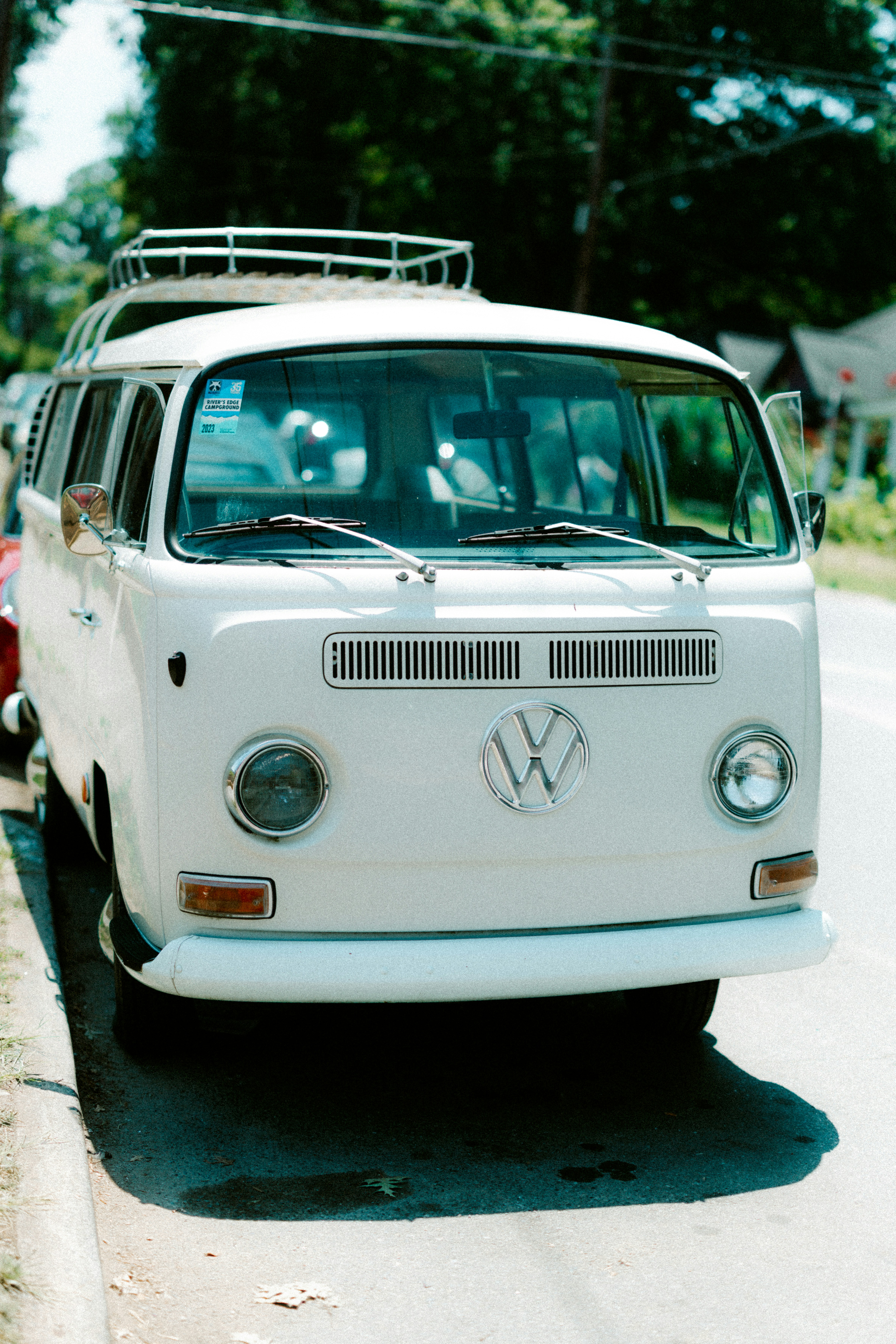 Vintage Volkswagen van parked on a sunlit street, showcasing its iconic design and charm.