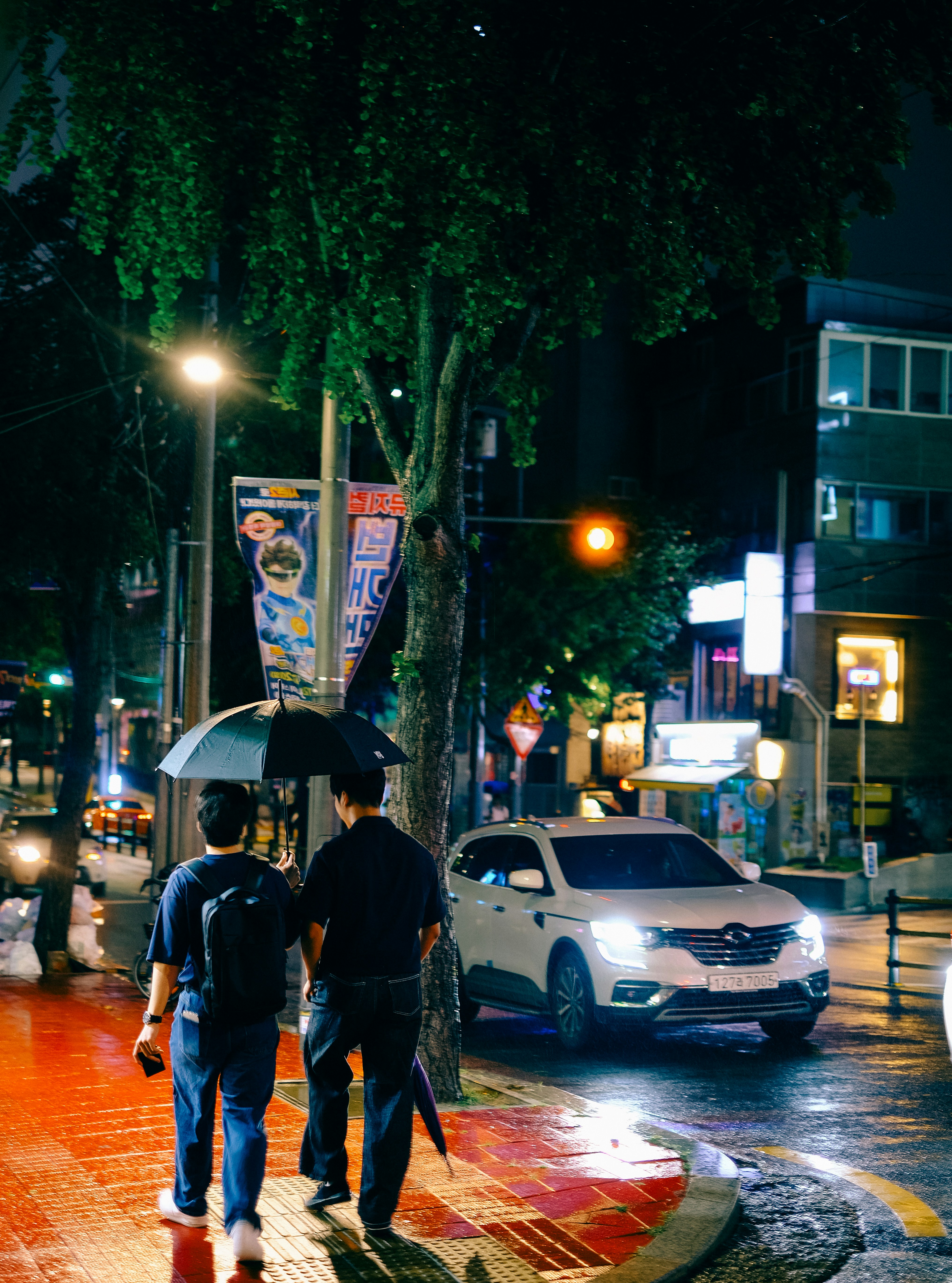 Nocturnal Stroll Under Umbrellas