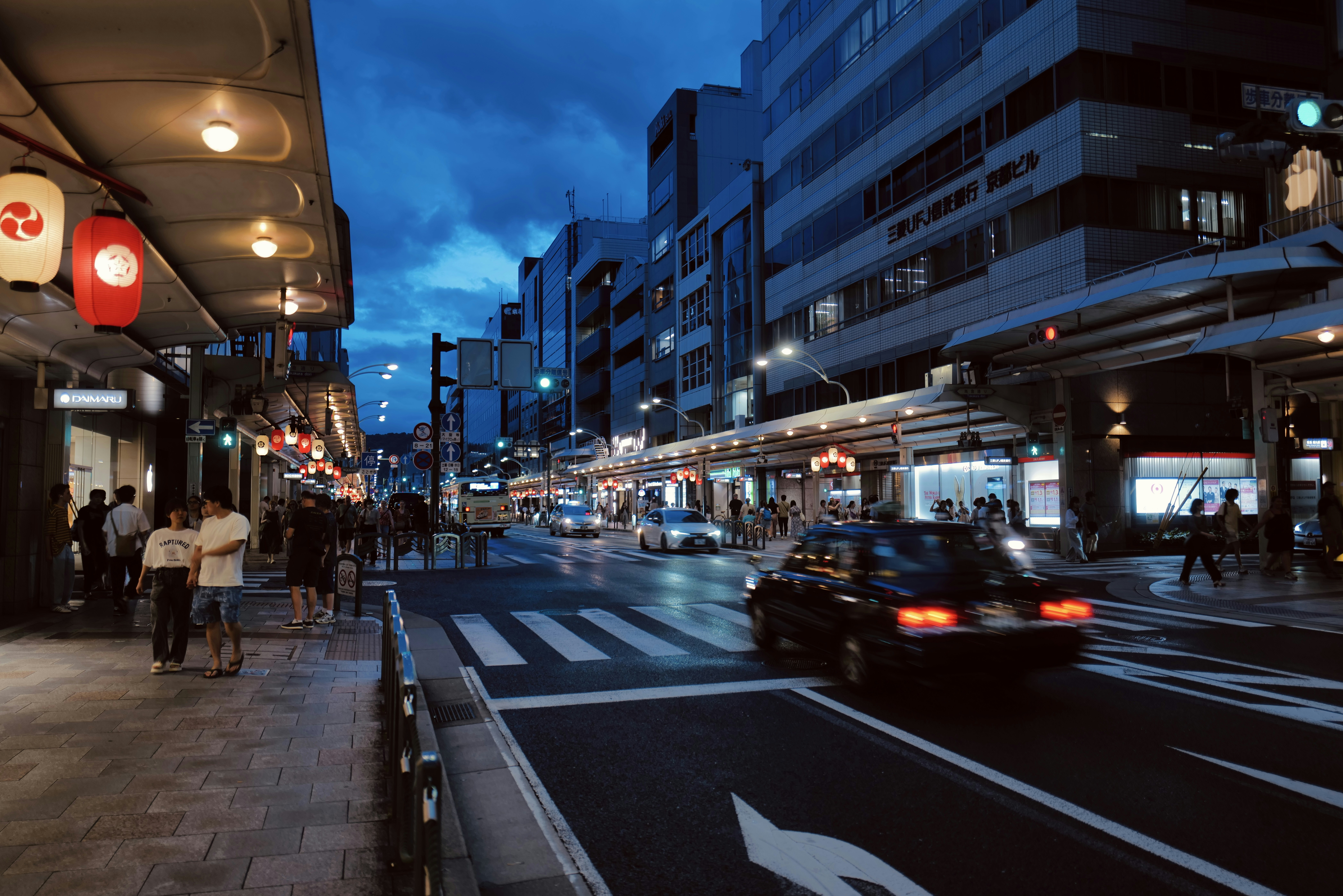 A city street scene at dusk is depicted.