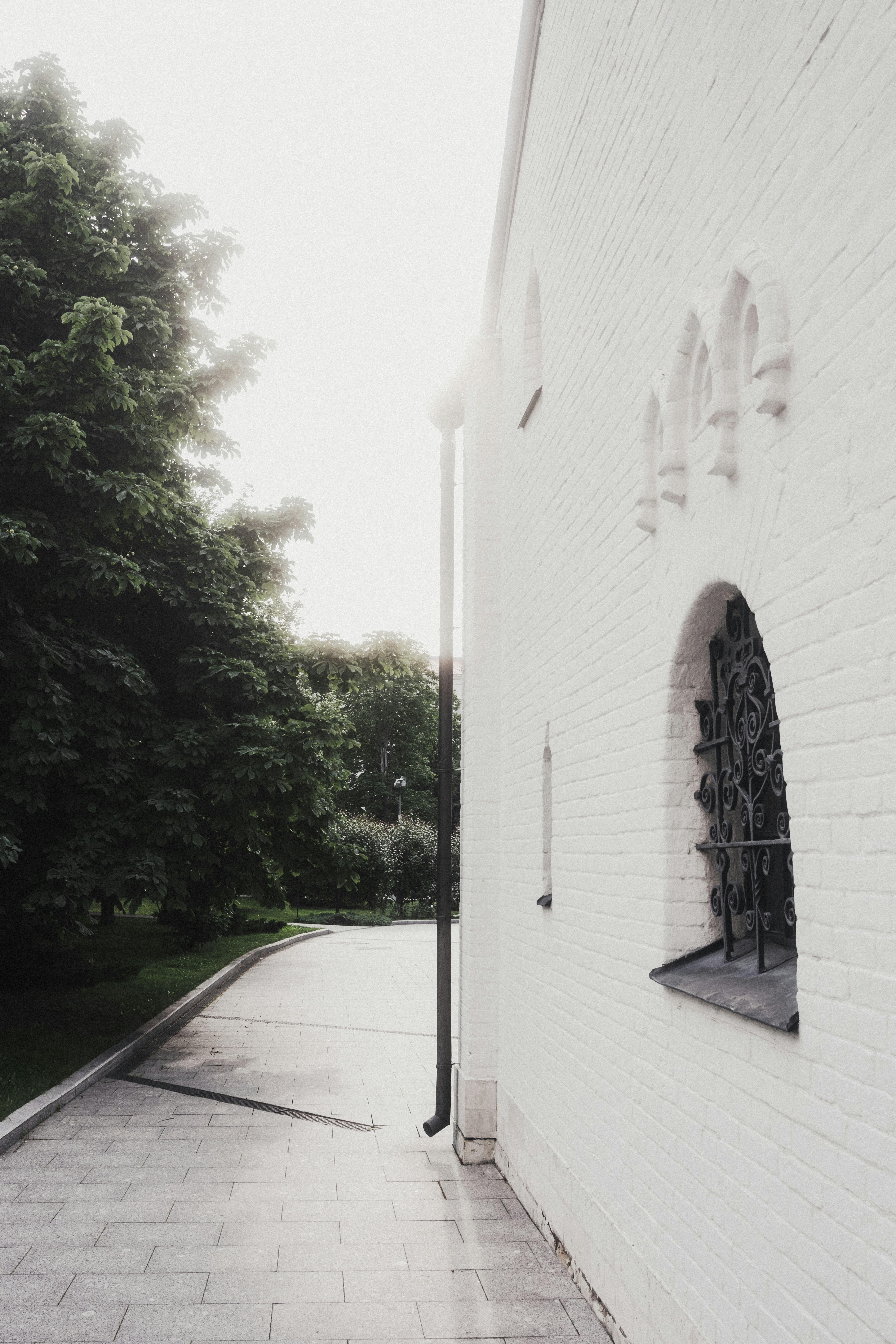 White building and a pathway through a park.