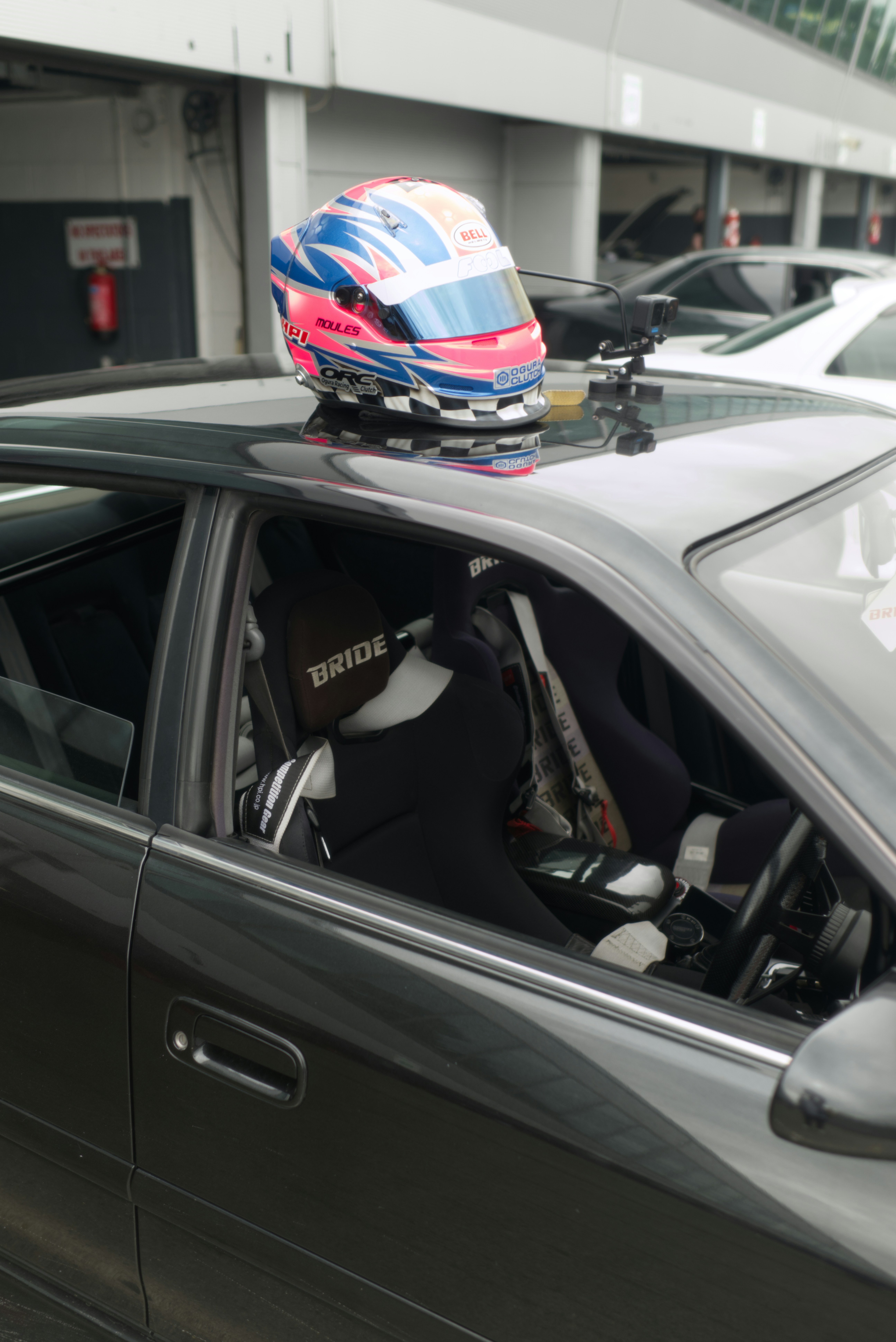 Helmet rests atop a car, ready for racing. photo – Free Cars Image on ...