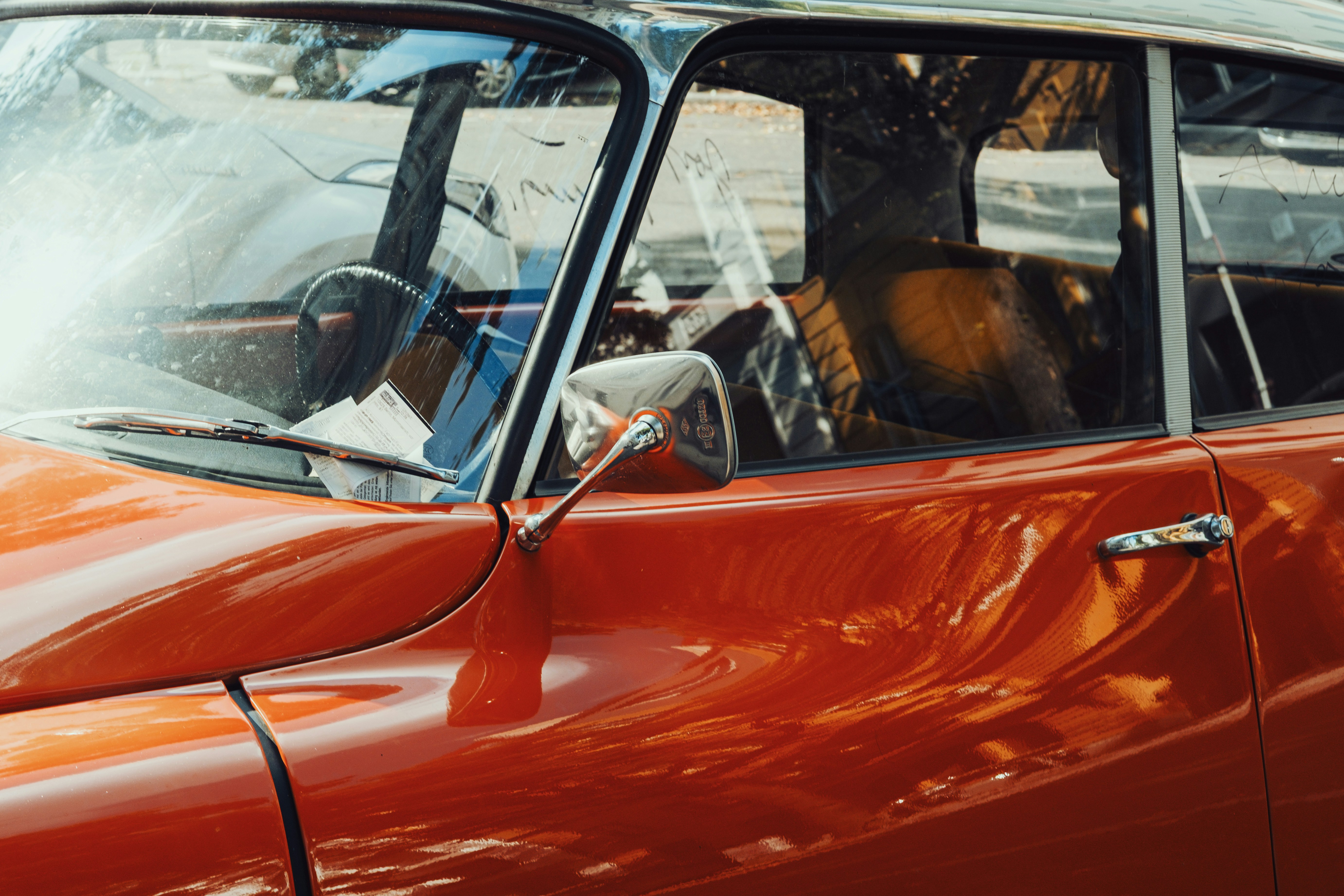 A classic red car's side view.