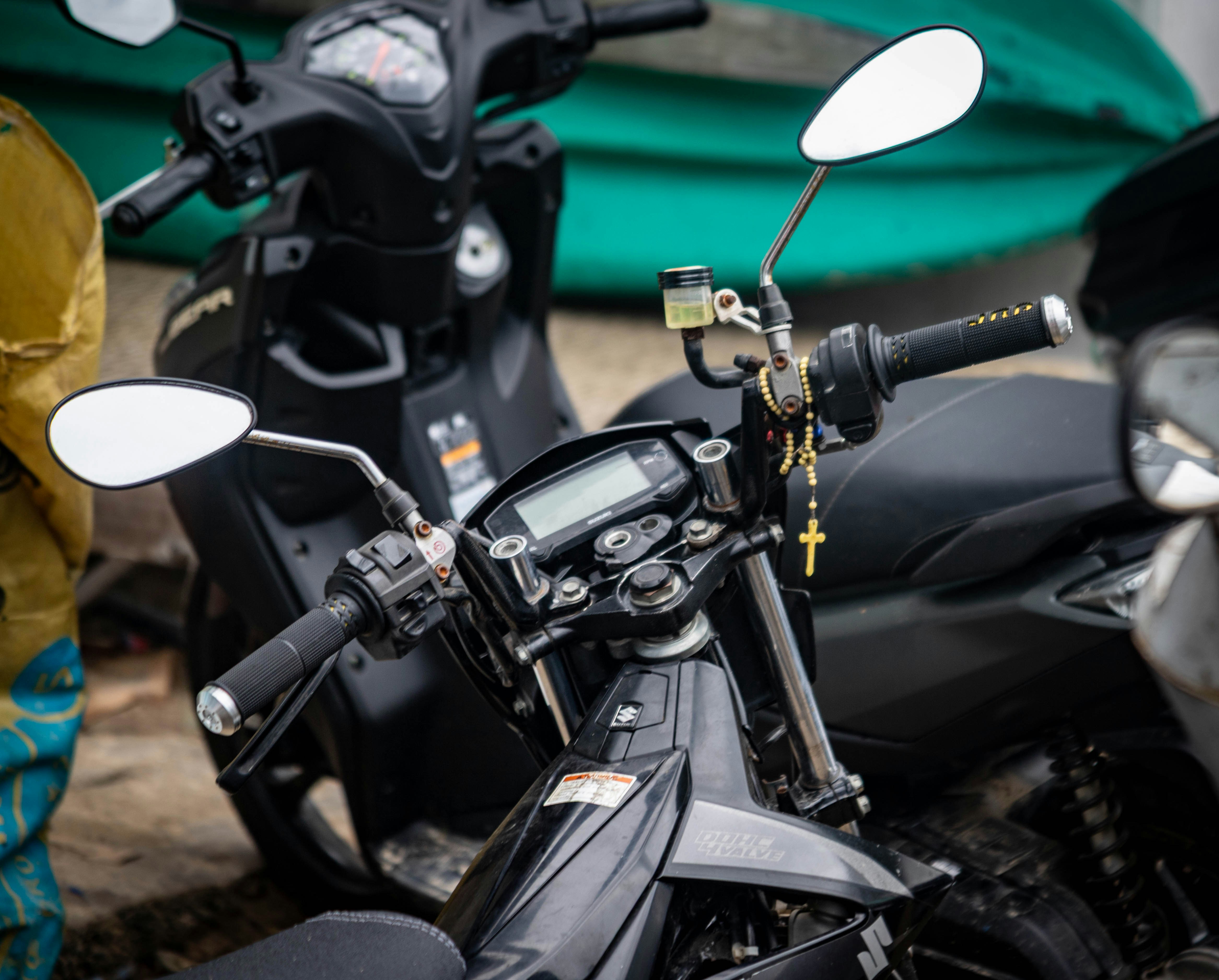 Motorcycle handlebars and dashboard are visible.