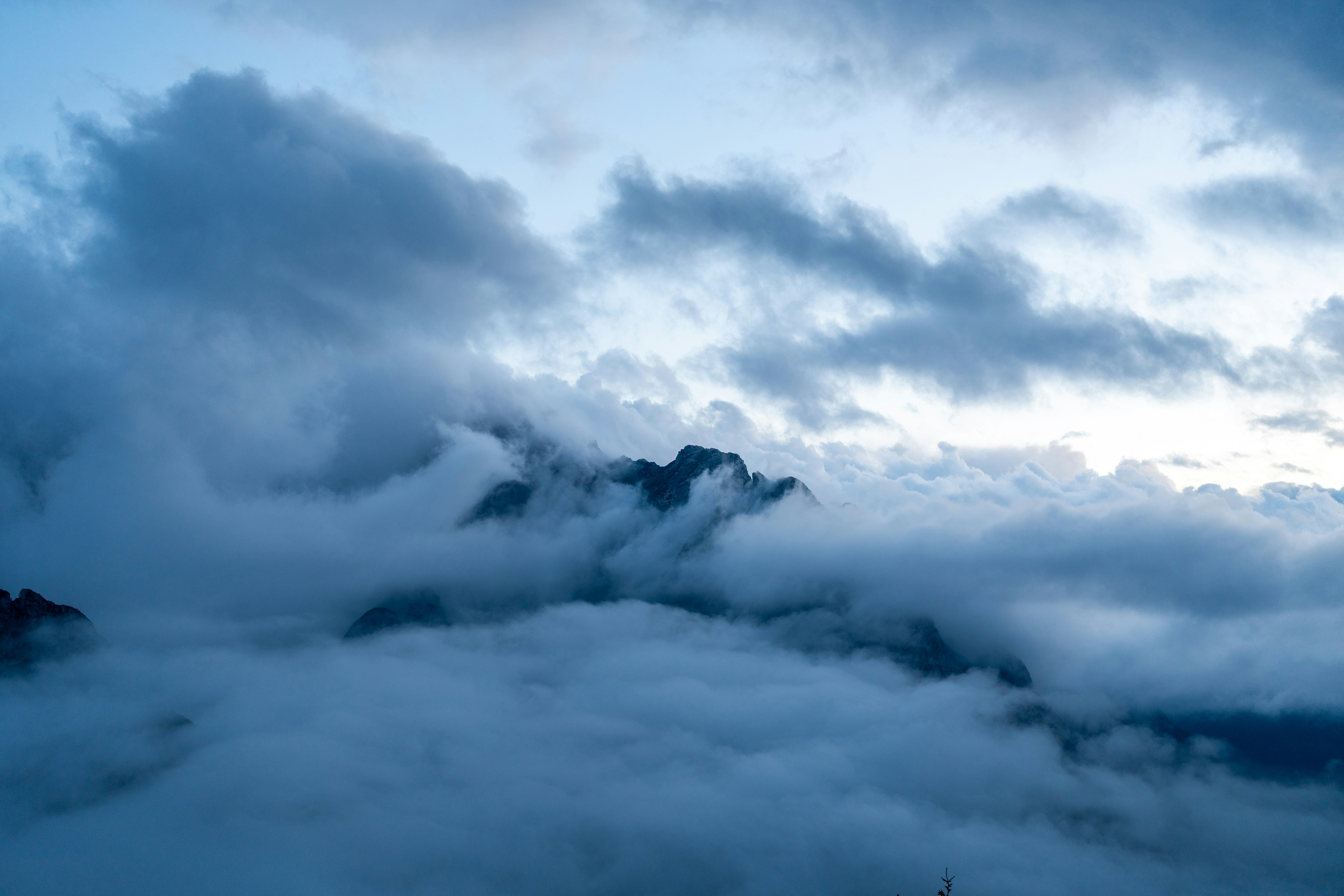 Cloudy Mountain Peak | Clouds obscure mountain peaks in a dramatic scene.