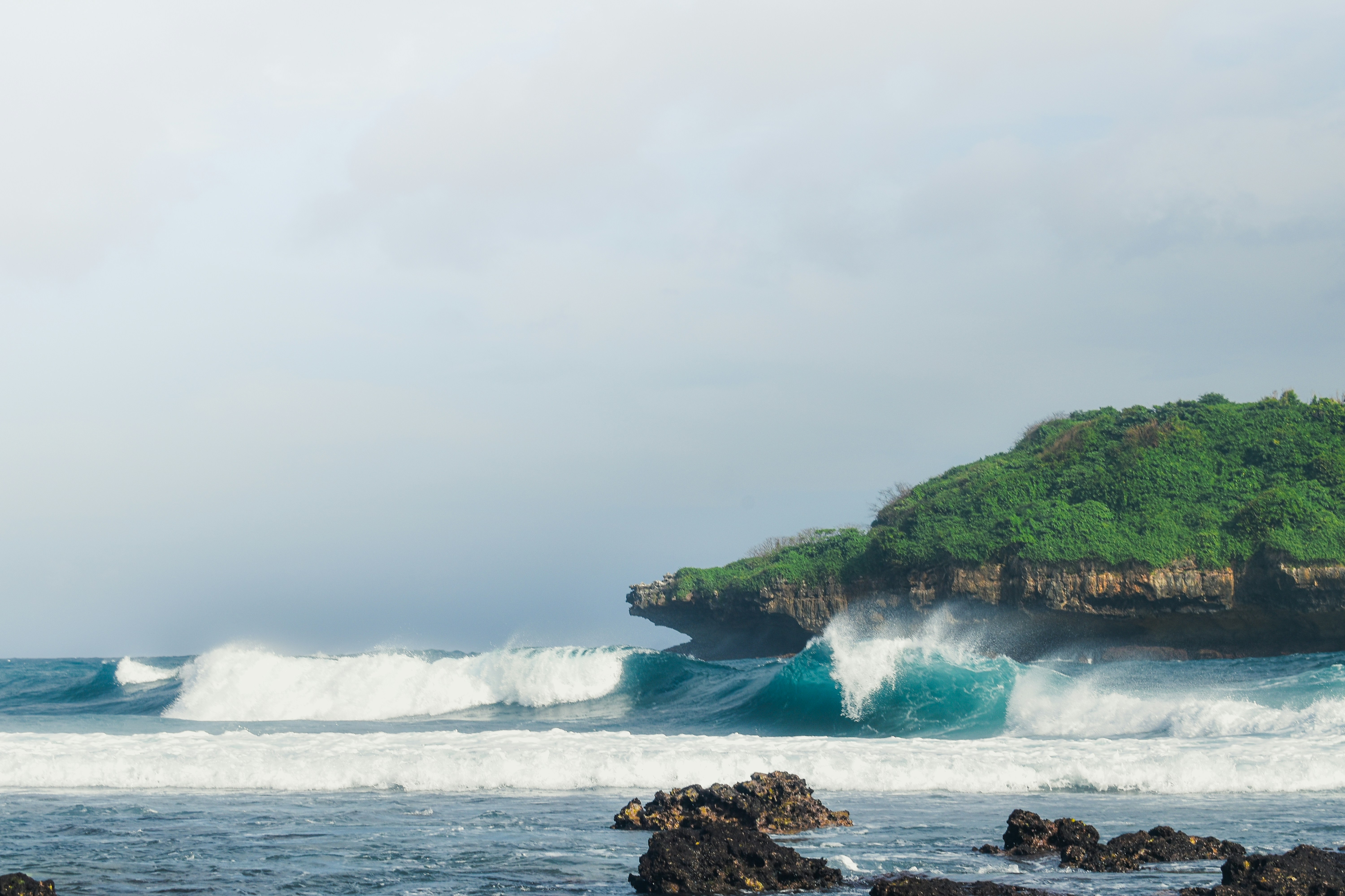 Emerald Waves Embrace Rocky Shores
