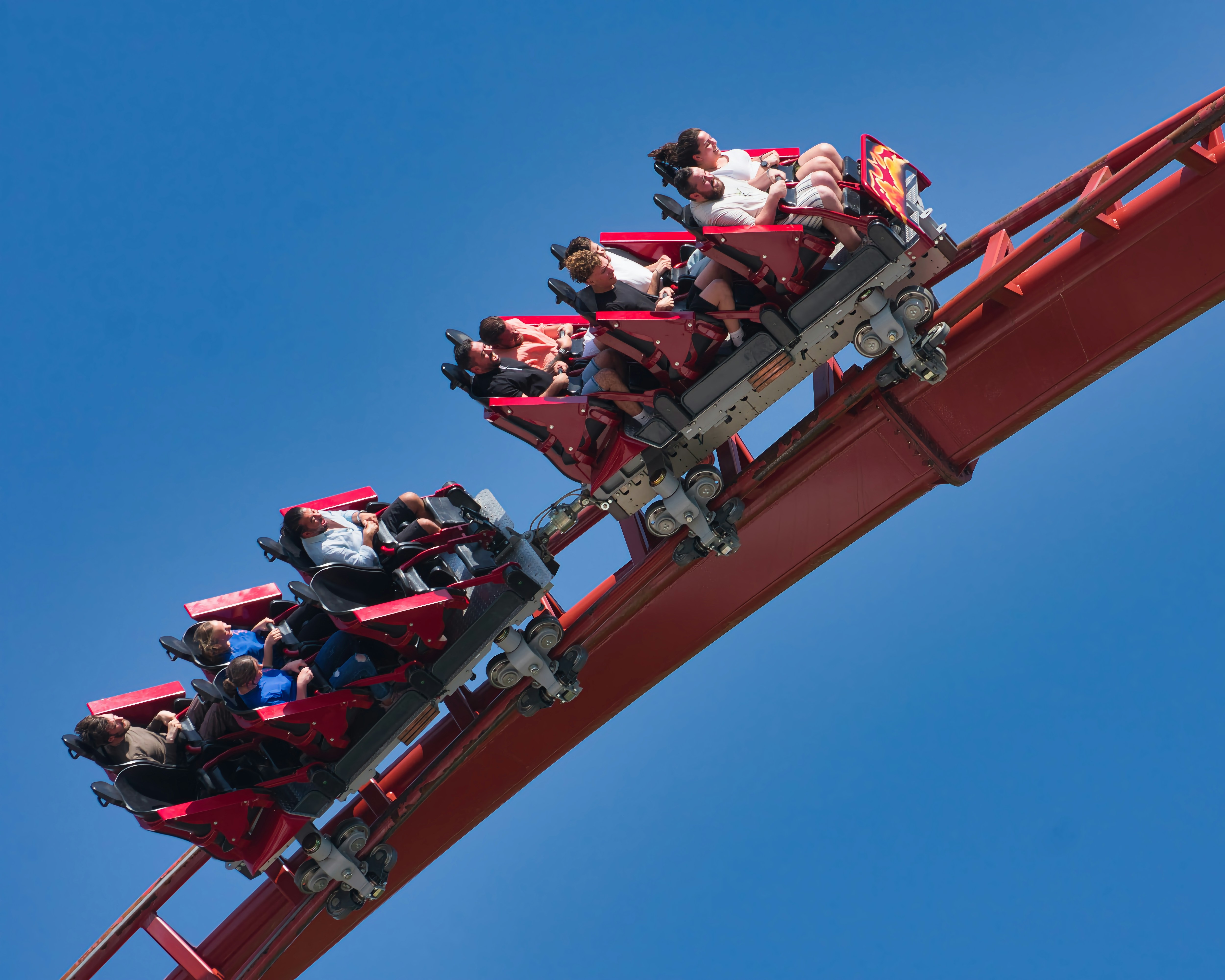 Sky Scream — Germany’s ultimate launch thriller. This Premier Rides Sky Rocket II catapults riders forward, backward, then forward again through a soaring vertical spike, a slow-motion heartline roll at 45 m, and a non-inverting loop—all packed into 263 m of intense fun. At 100 km/h and packed with force reversals, it’s one of the most compact and thrilling coaster experiences in Germany. Type: Launched Coaster (Premier Rides Sky Rocket II) Opened: 12 April 2014 Height: 45.7 m Length: 263 m Top Speed: ~100 km/h Inversions: 1 (Inline Roll + non-inverting loop) Launches: Multi-pass LSM: forward | People ride a thrilling roller coaster.