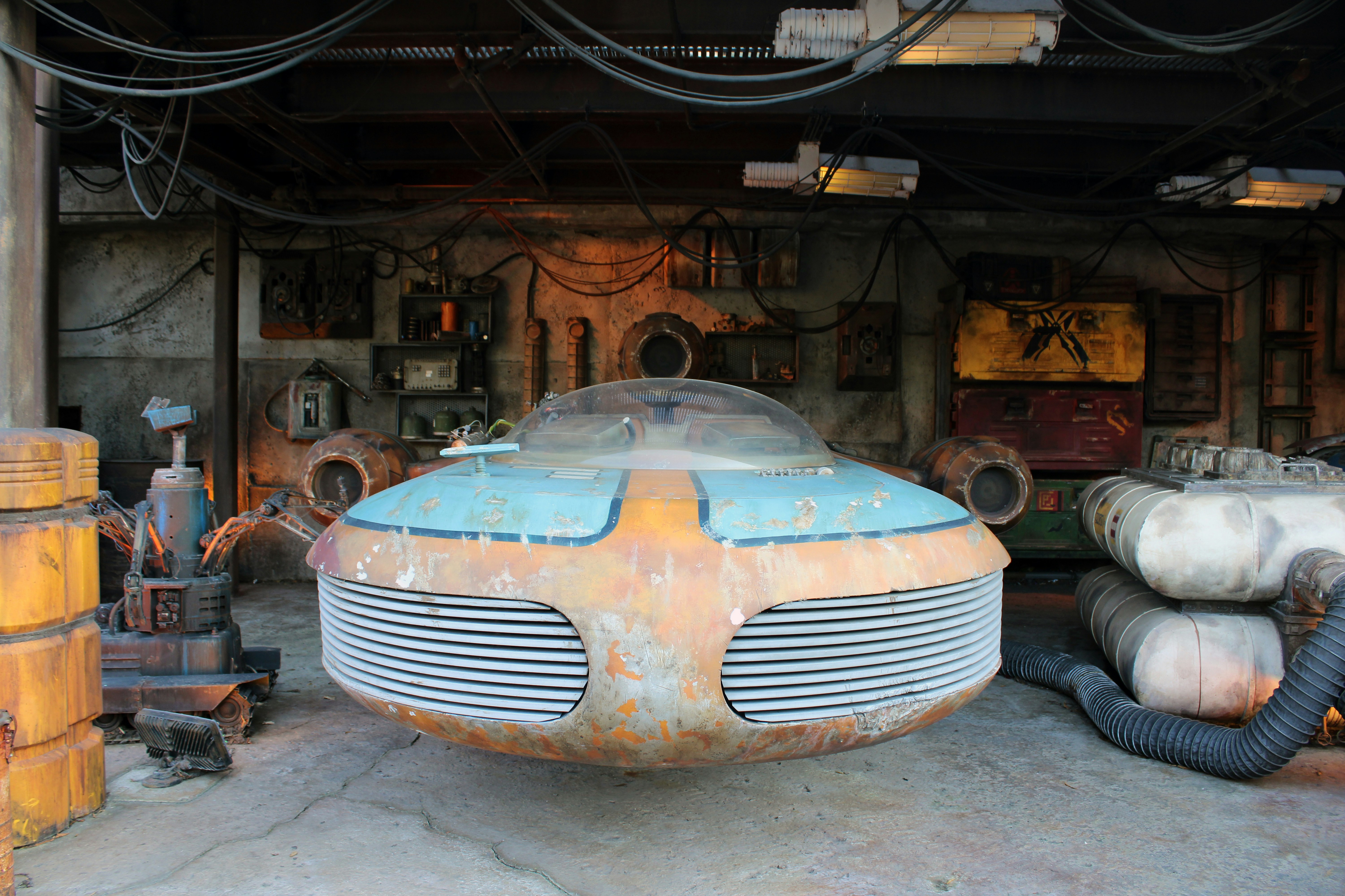 Dome-Crowned Rust Vessel in a Cluttered Workshop