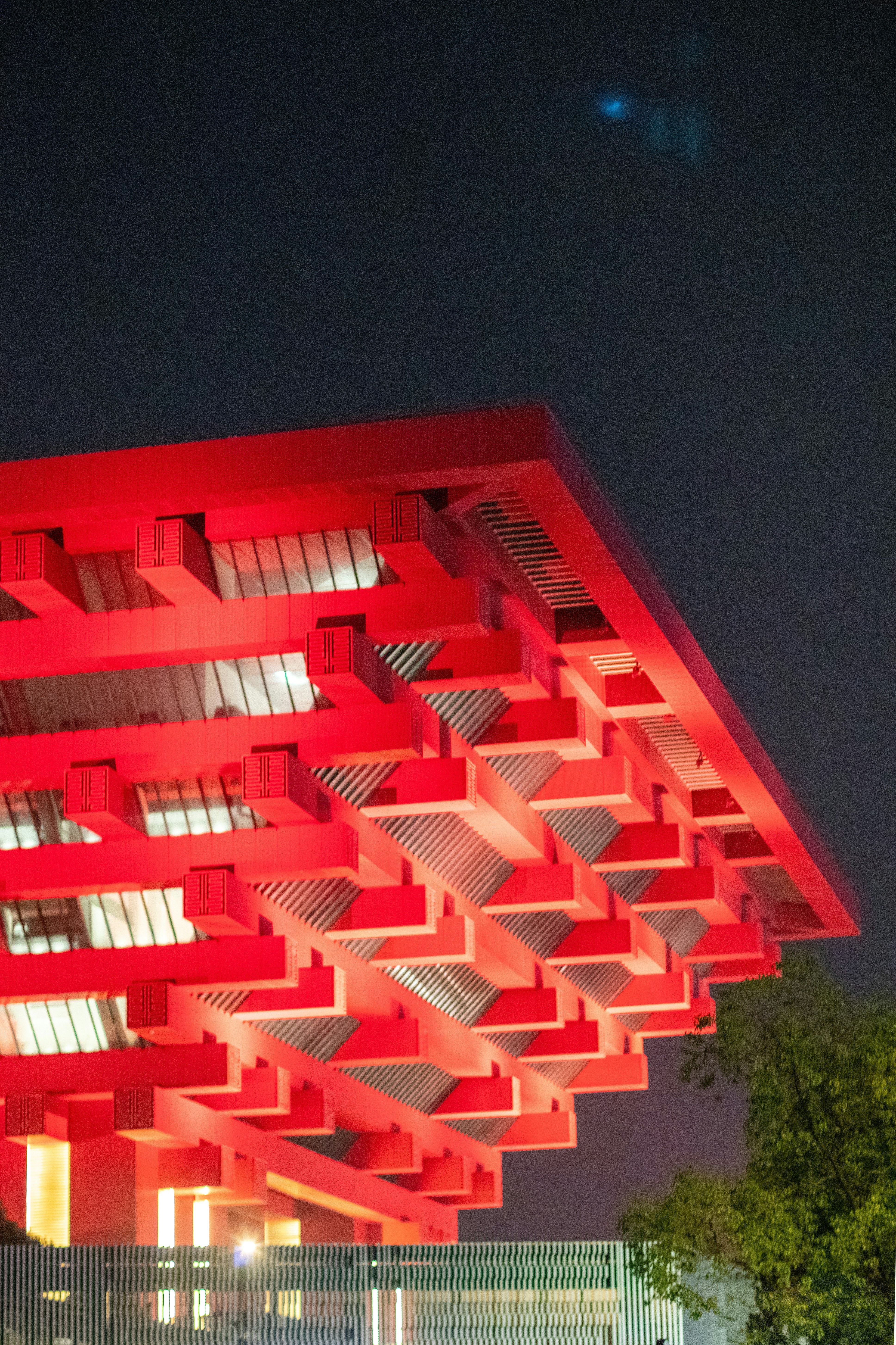 A red building illuminated at night.