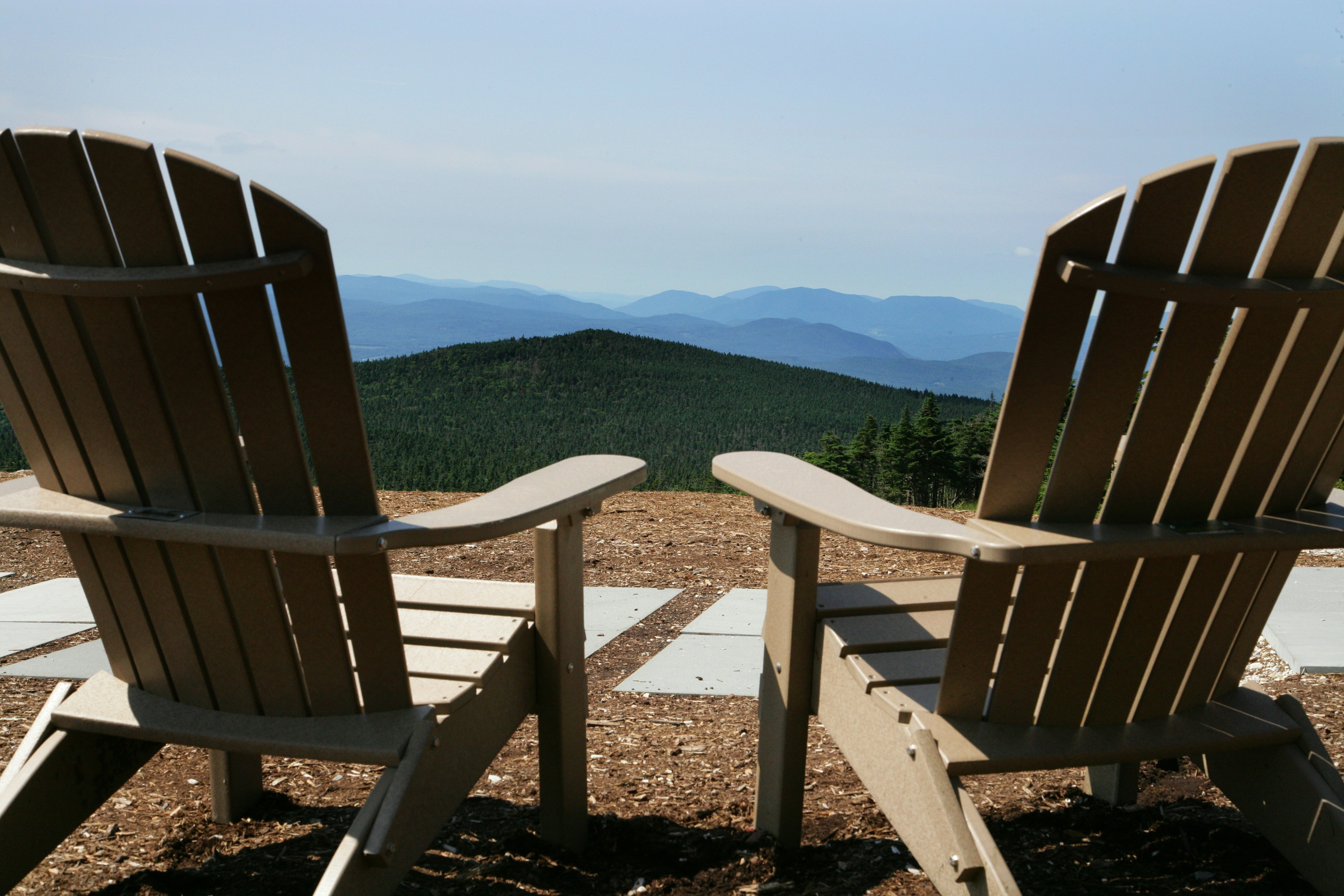 Quiet Outlook: Twin Adirondack Chairs Framing a Distant Ridge