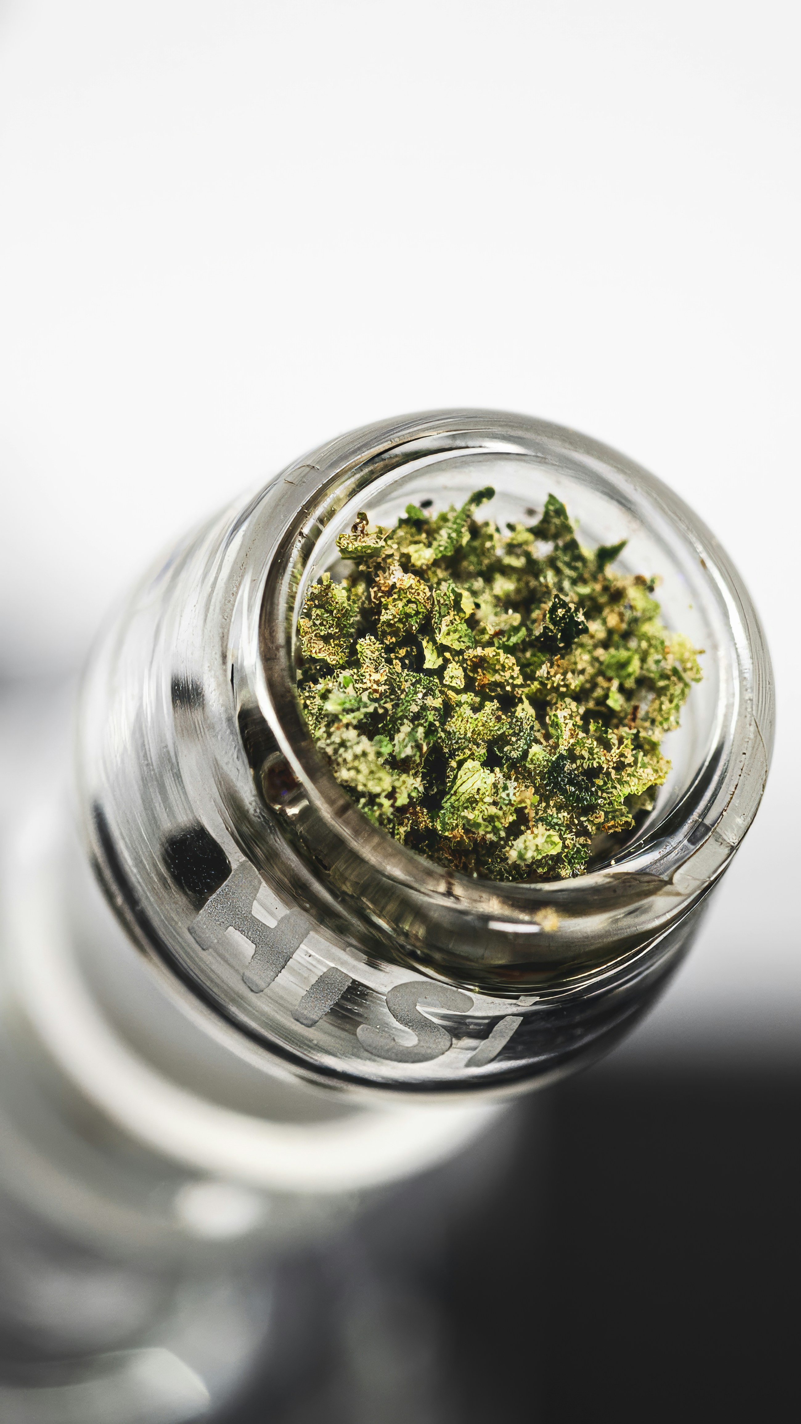 A freshly grounded bowl of some top shelf cannabis, pictured in a Hi-Si bubbler. | Marijuana buds inside a glass bowl are shown.