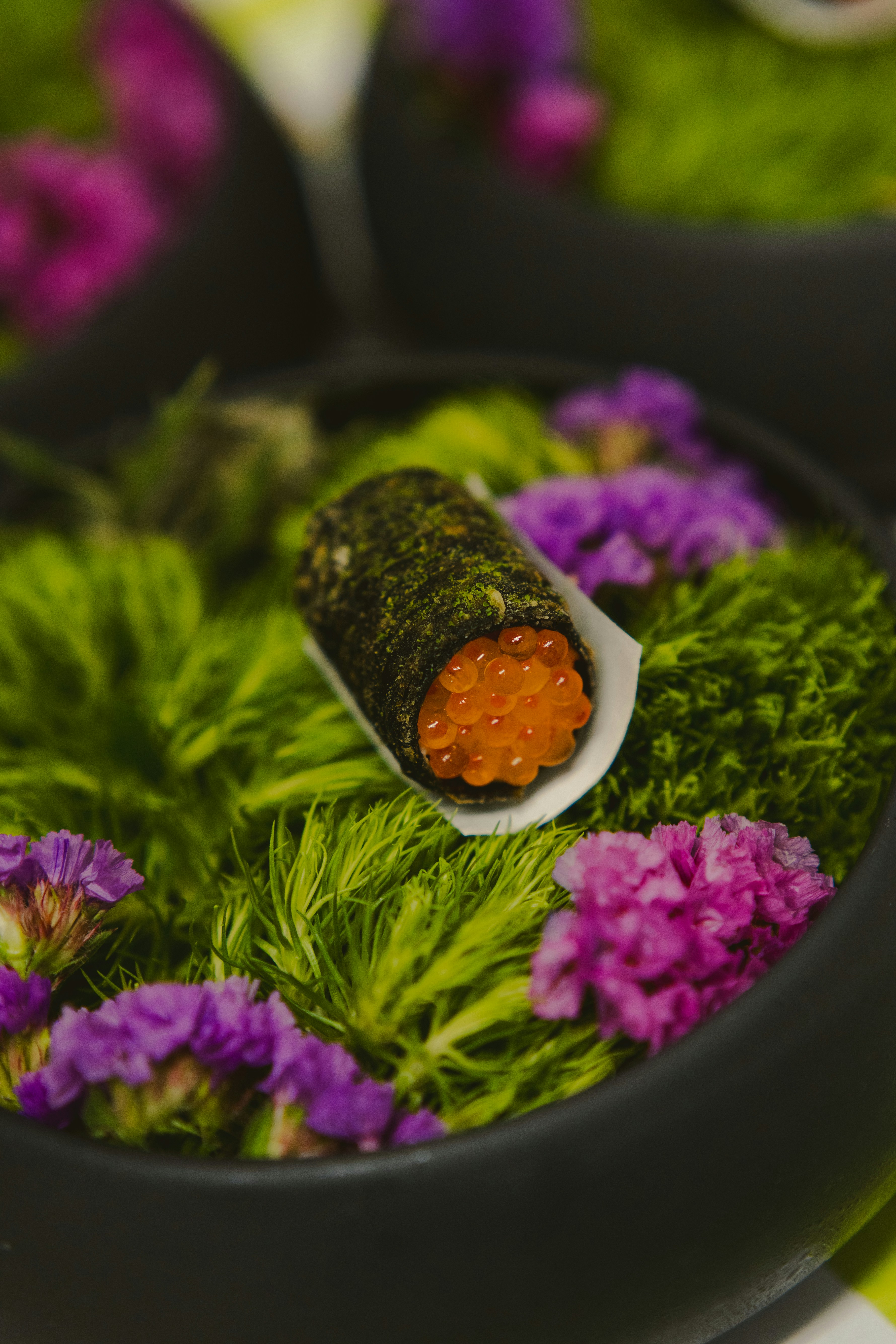 Sushi roll with caviar and flowers.
