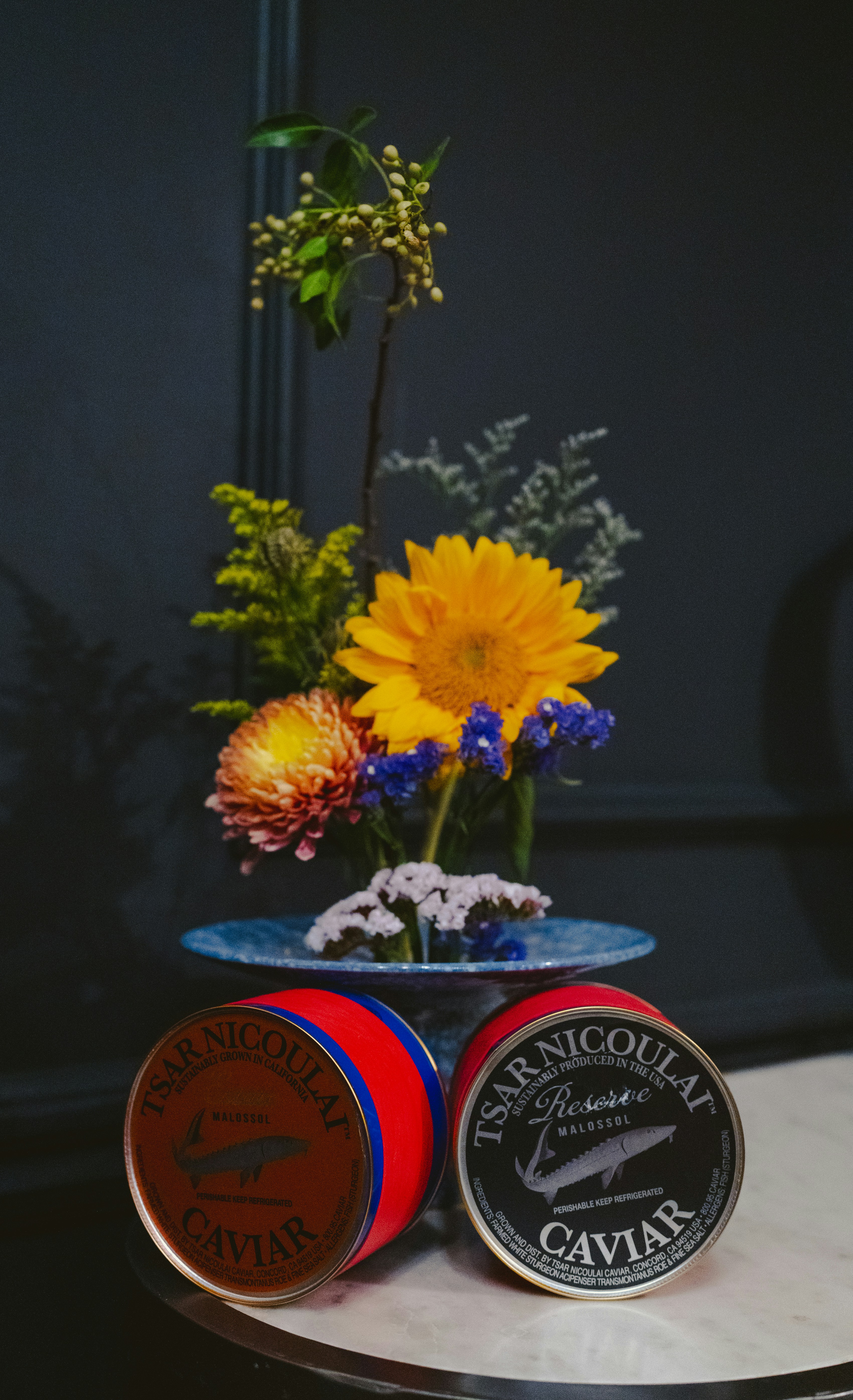 Sunflower centerpiece over premium caviar: a moody still-life