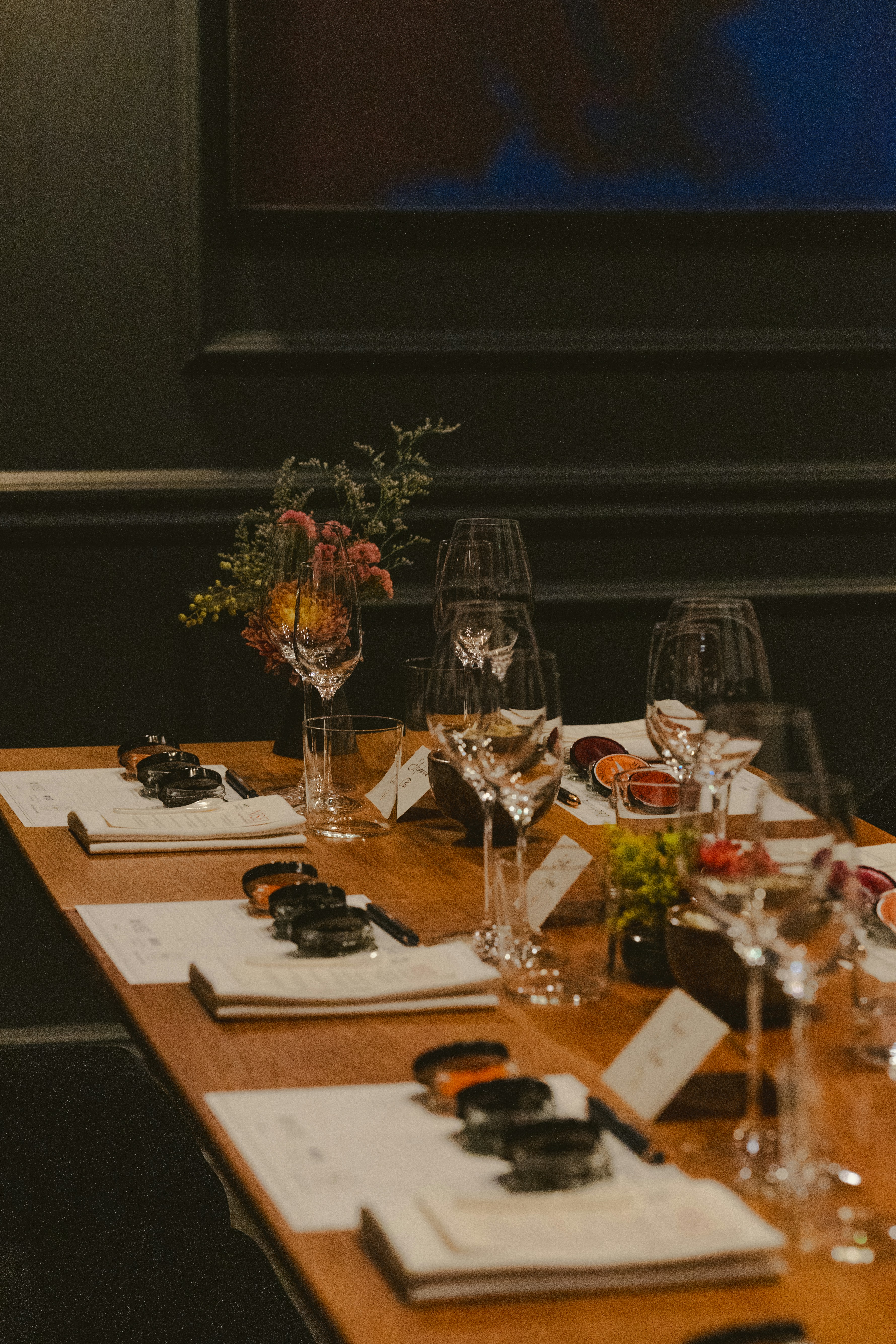 A dinner table is elegantly set with glasses.