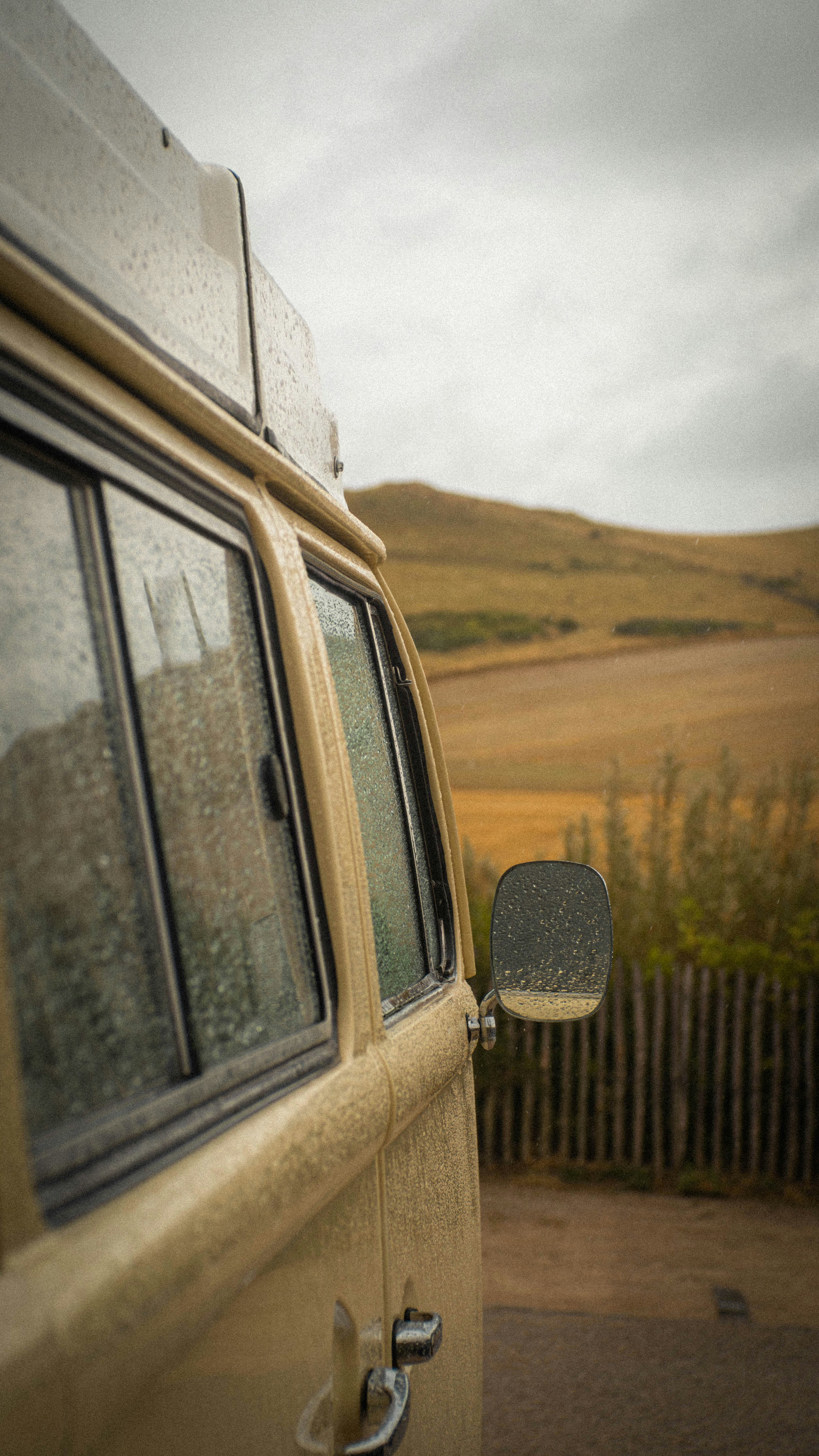 Raindrops and Open Roads | A van parked on a cloudy, rural road.