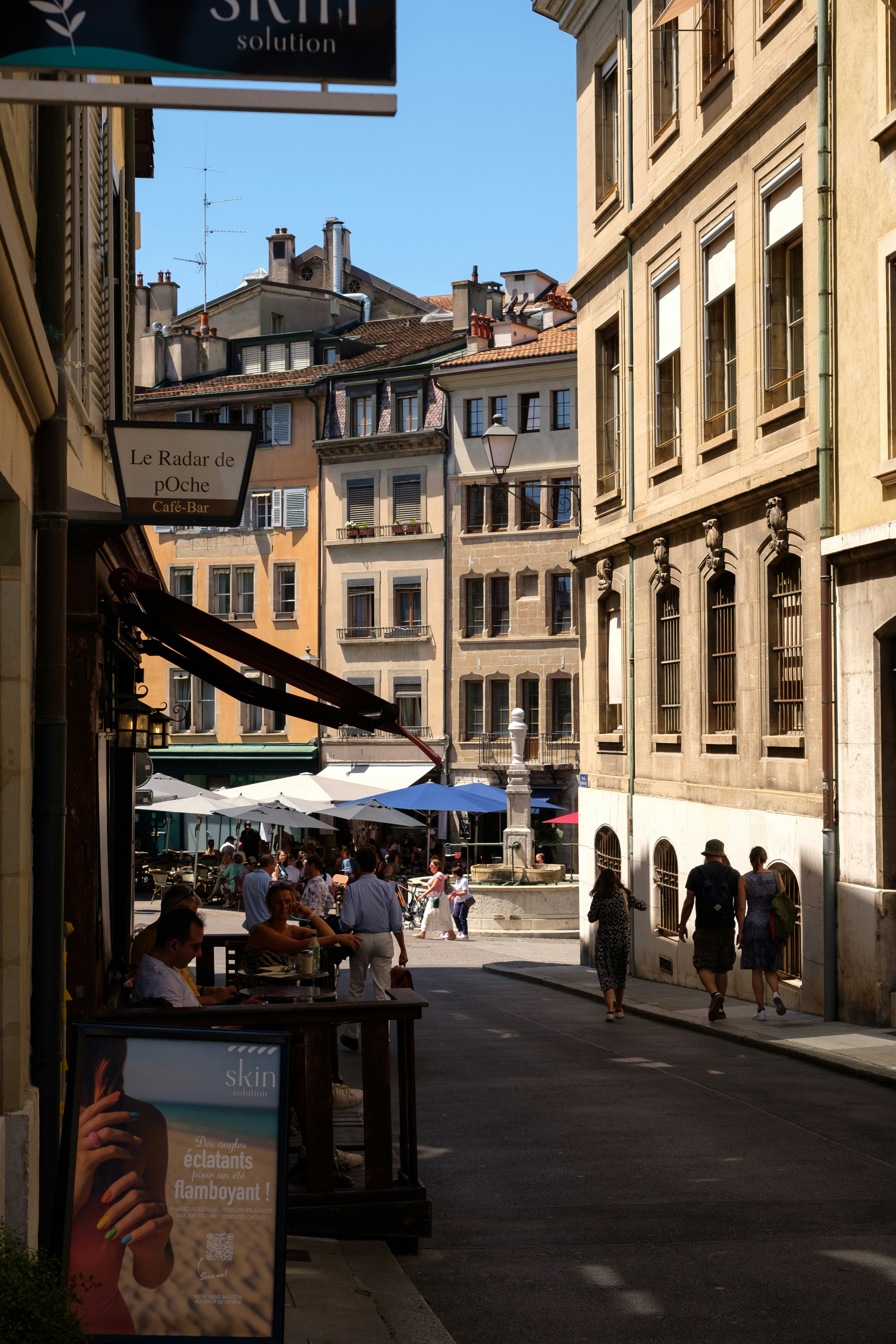 A charming european street scene with people and buildings.