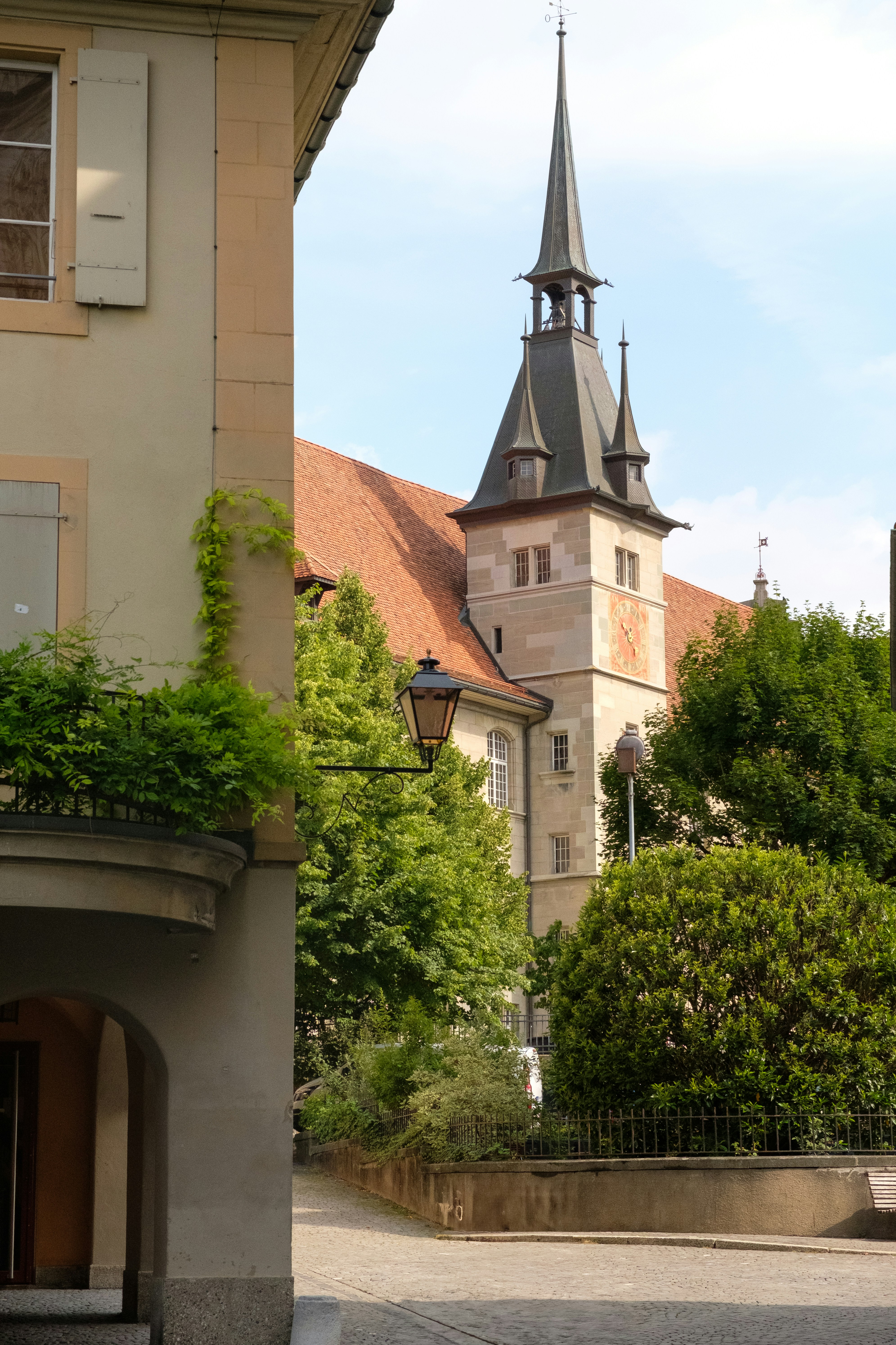 Spire Rising Over a Cornered Street: Sunlit European Architecture