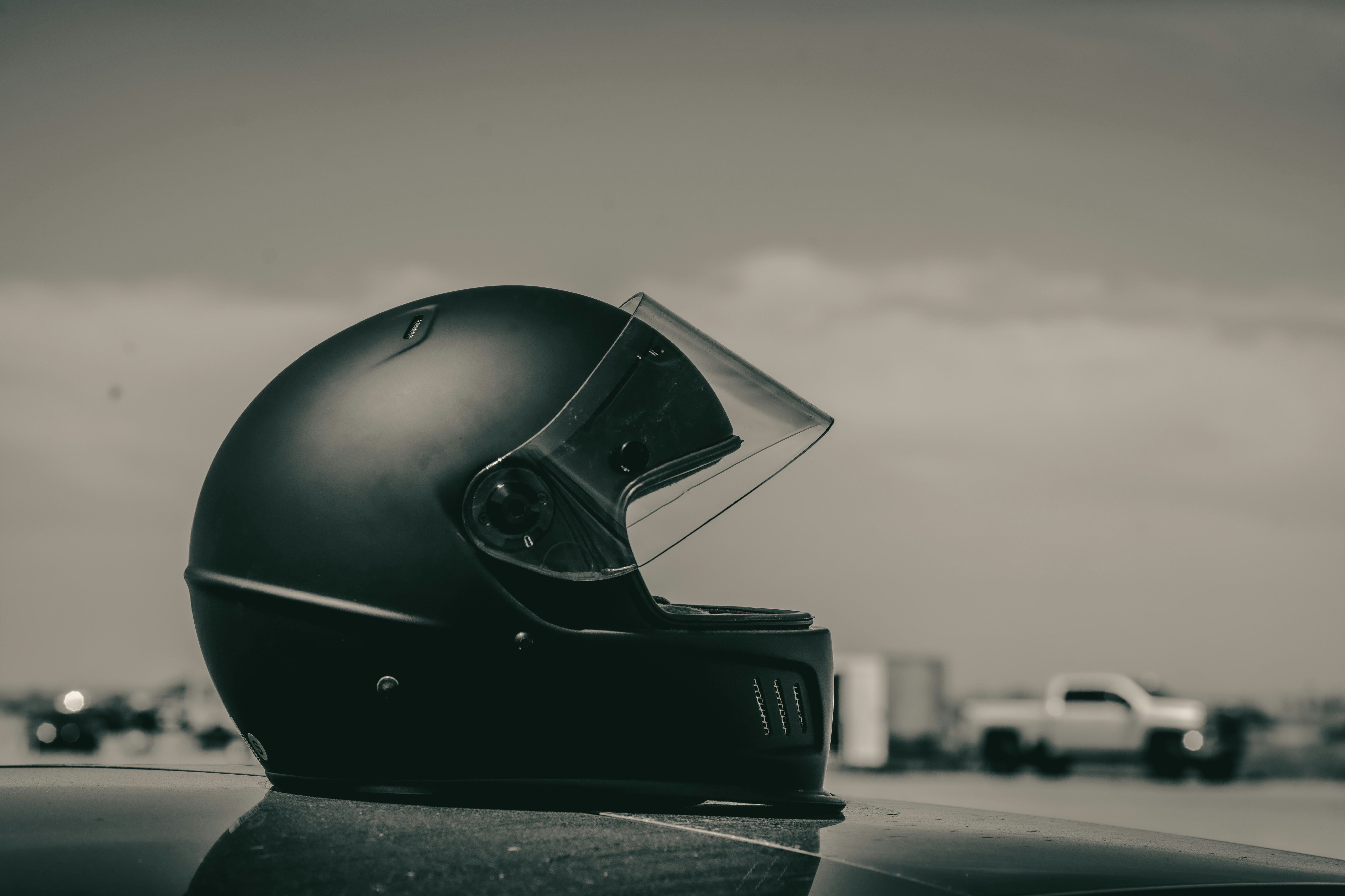 Motorcycle helmet rests on a reflective surface.