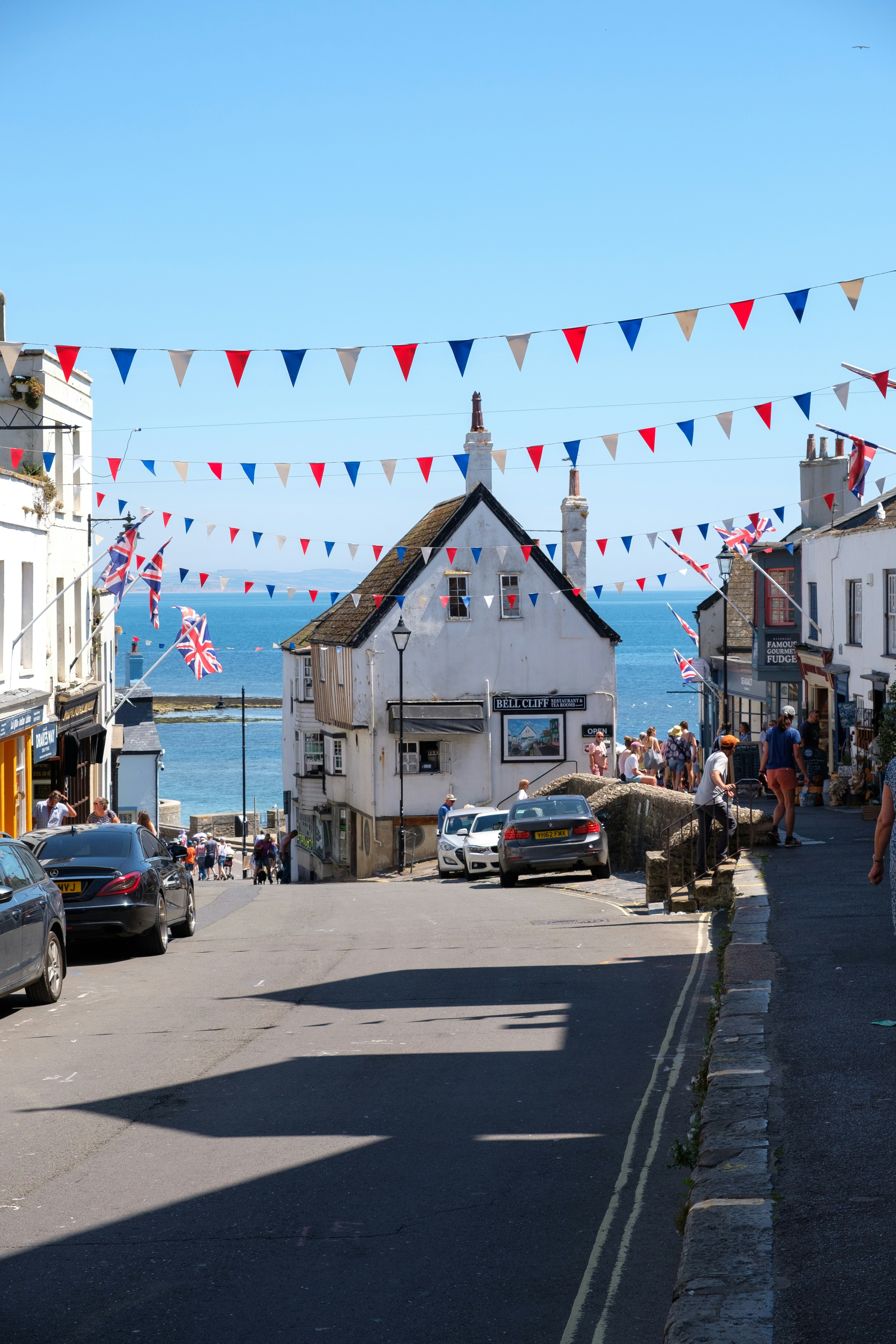 A quaint seaside town street decorated with flags. photo – Free Car ...