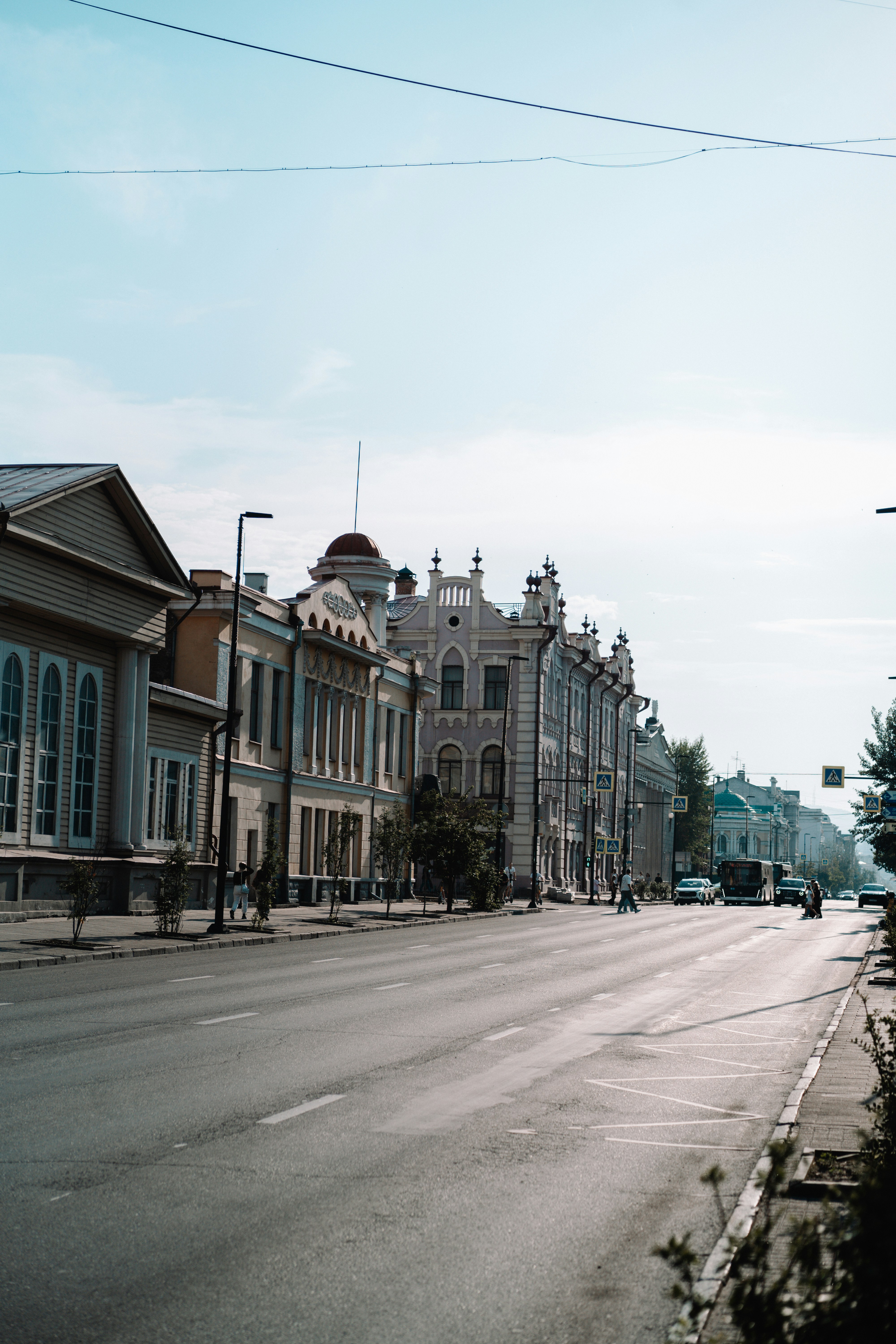 A street of elegant buildings under a clear sky.