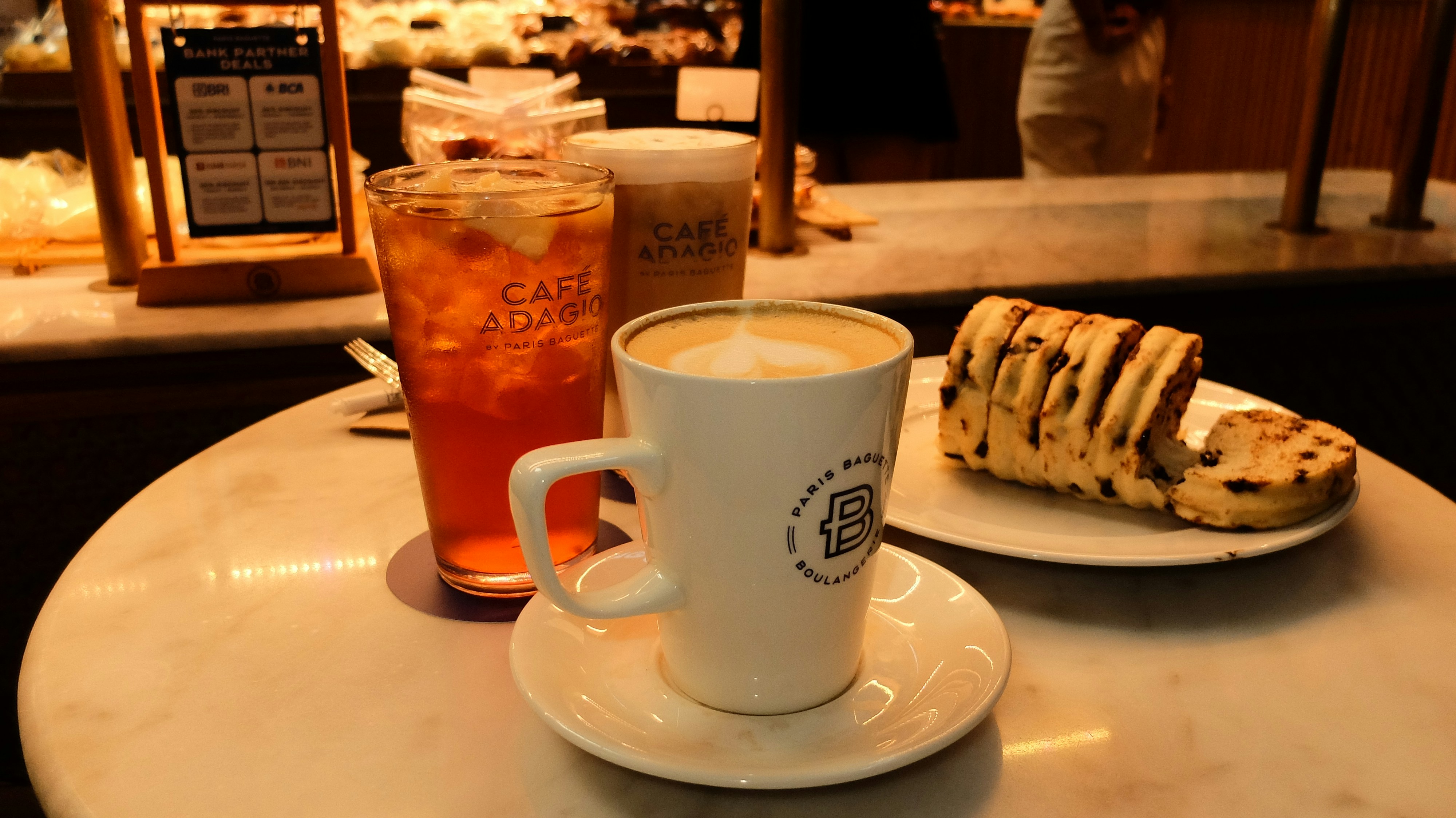Drinks and pastries are on a table.