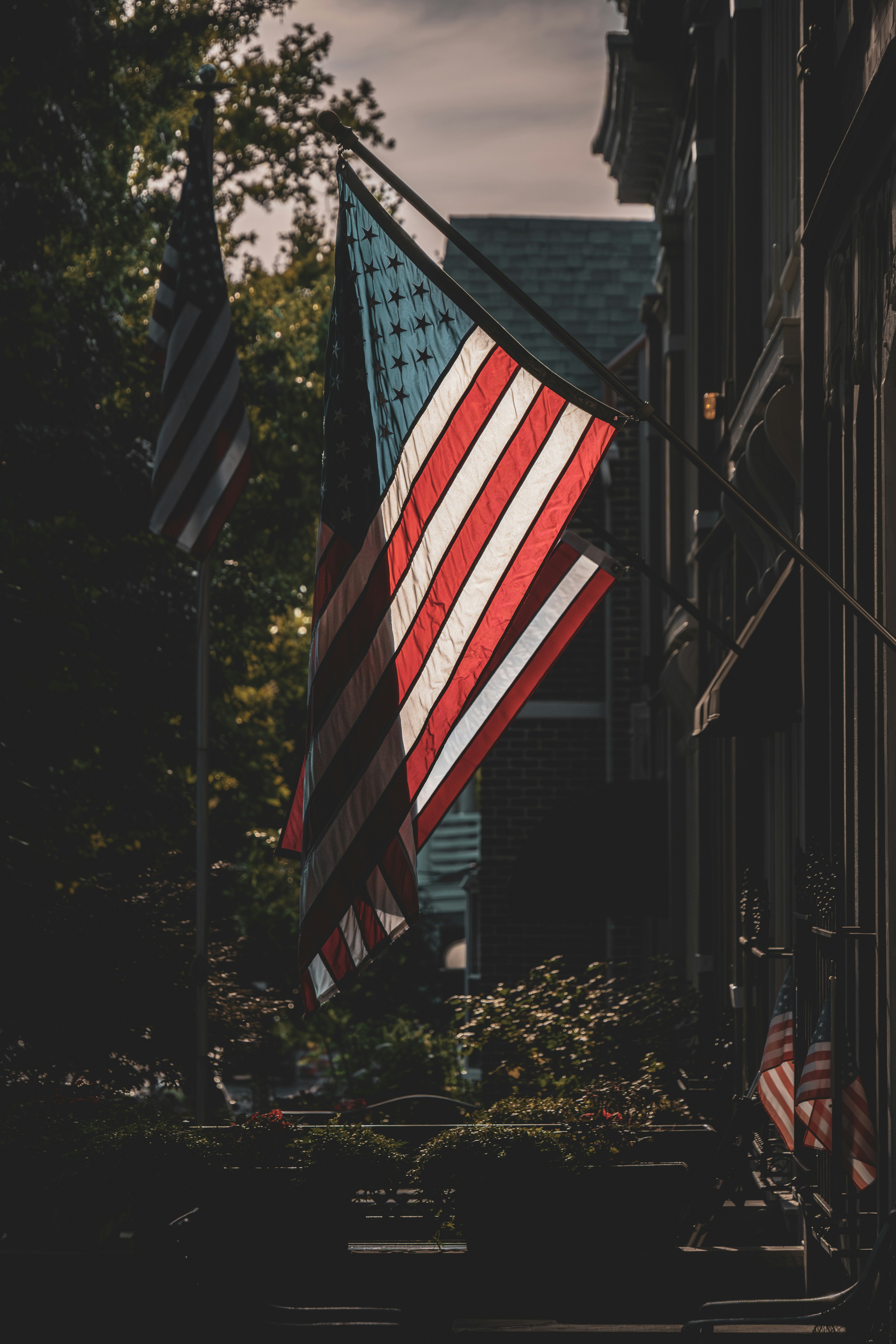 American flags wave in front of a house.
