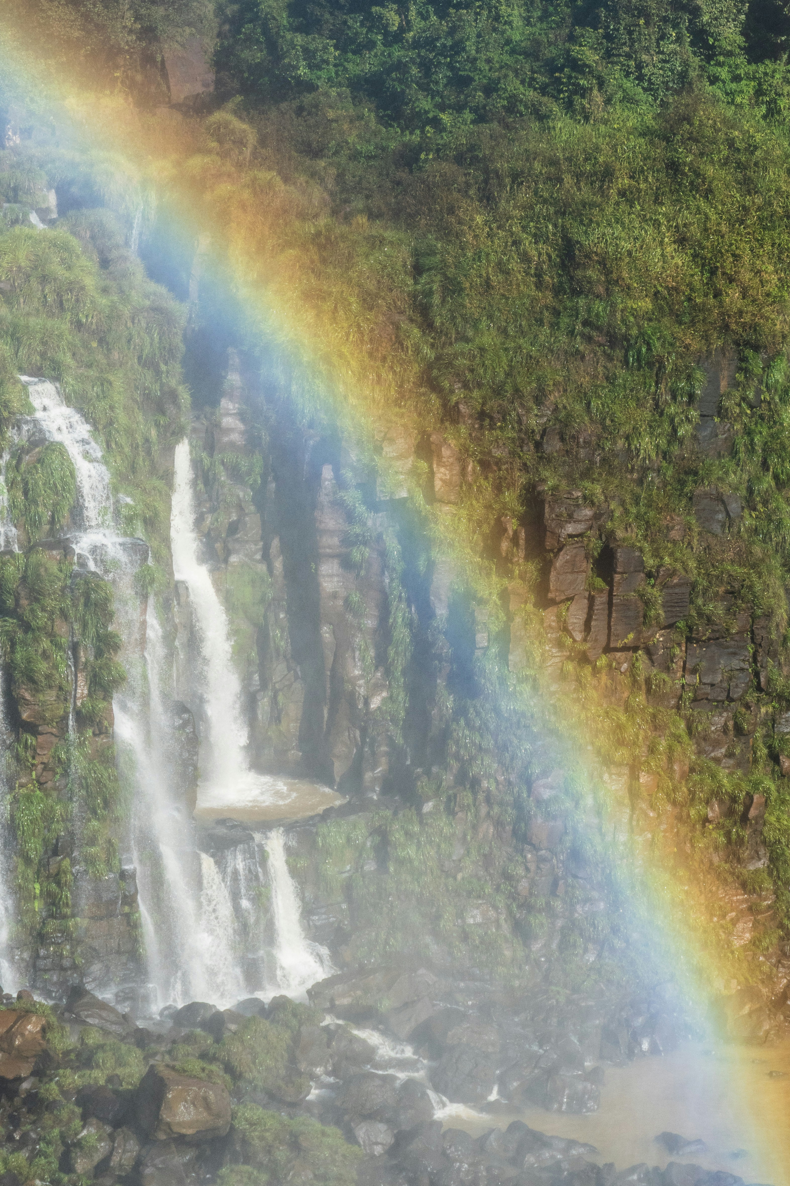 A beautiful rainbow arches over waterfalls. photo – Free Waterfall ...