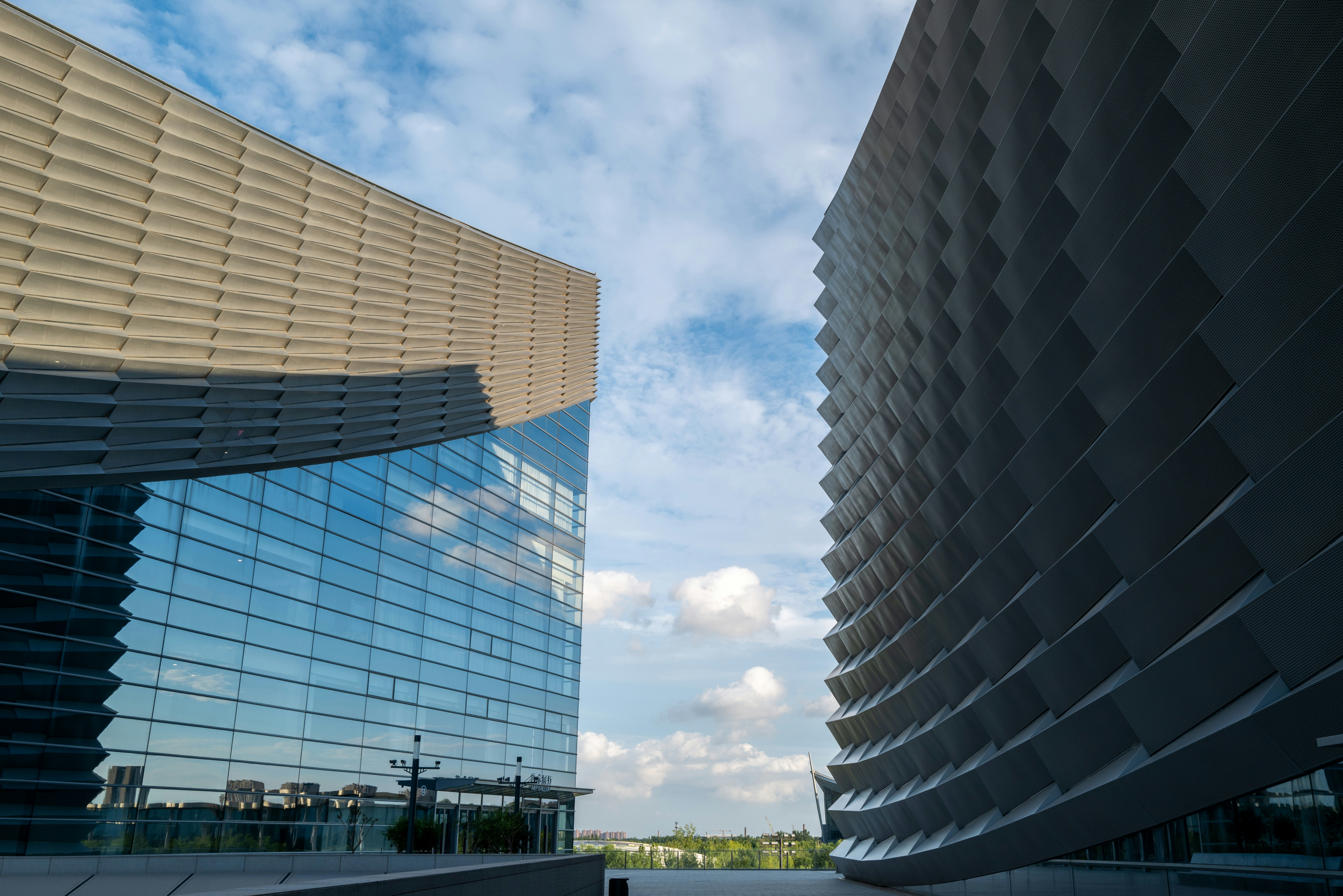 Modern buildings stand tall beneath a cloudy sky.
