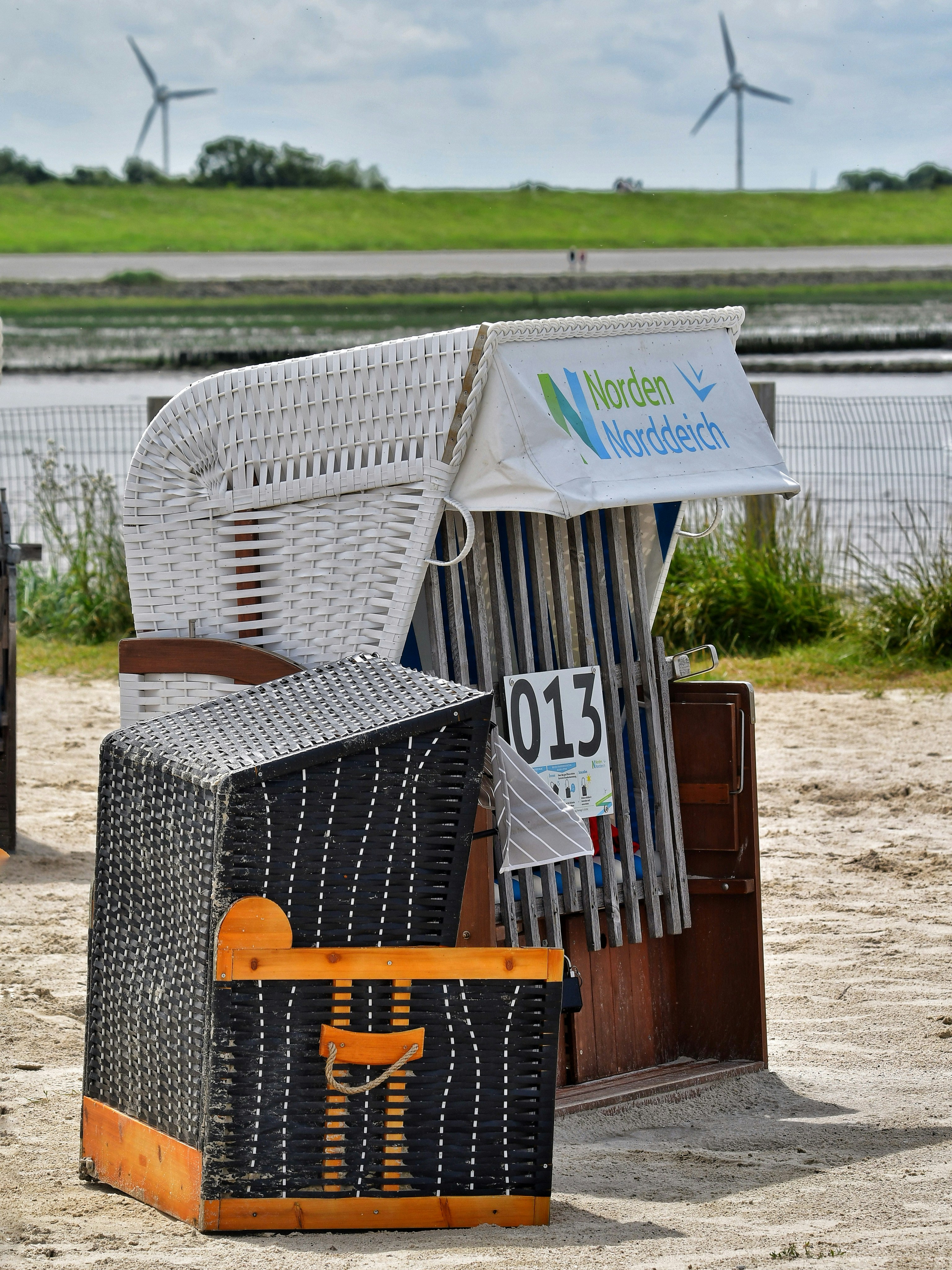 Stranded Beach Gear: A Patchwork of Chairs by the Dunes
