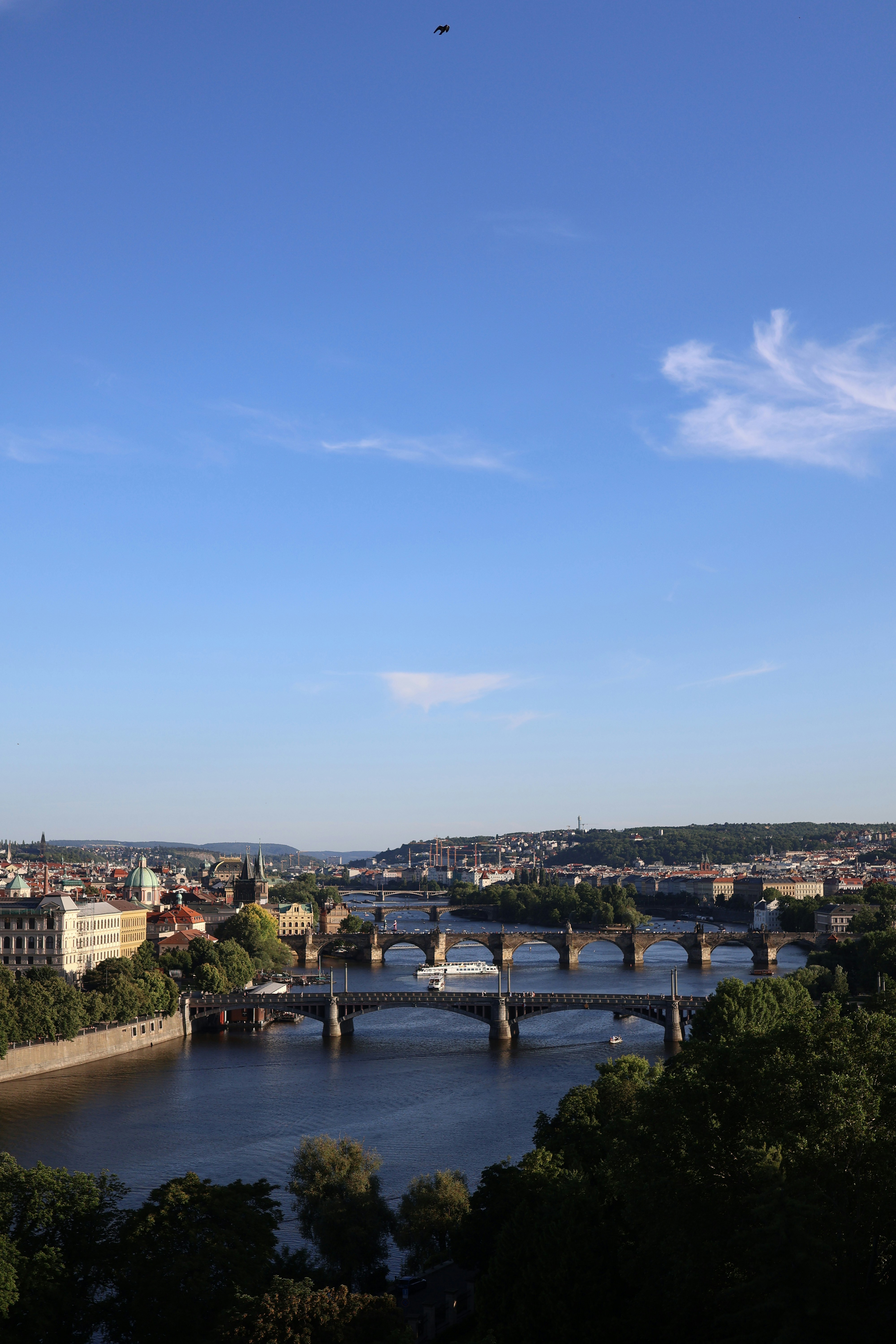 Bridges | Bridges span a river in prague on a sunny day.