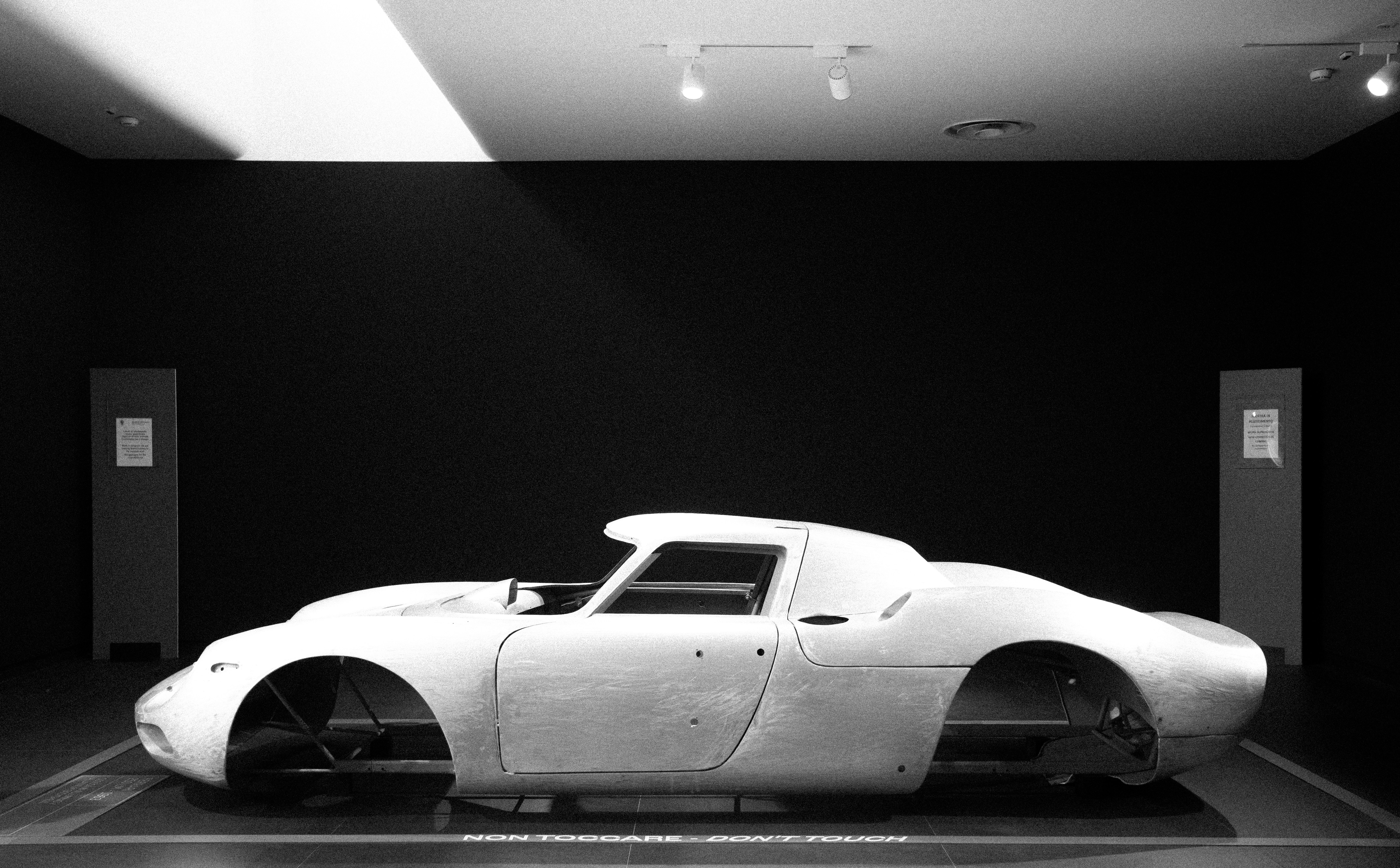 A classic car body is on display.