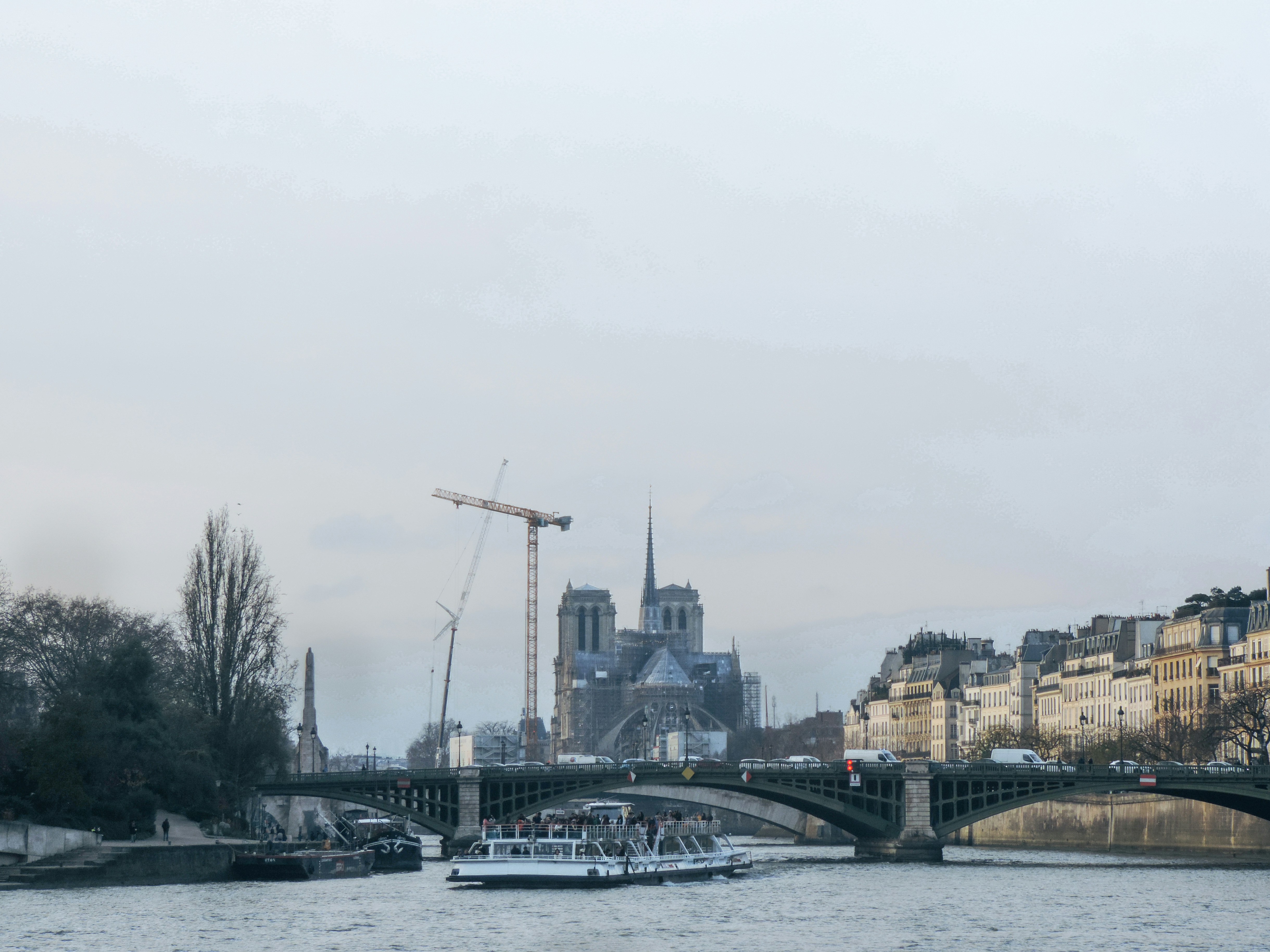 Notre dame cathedral, paris, under overcast skies.
