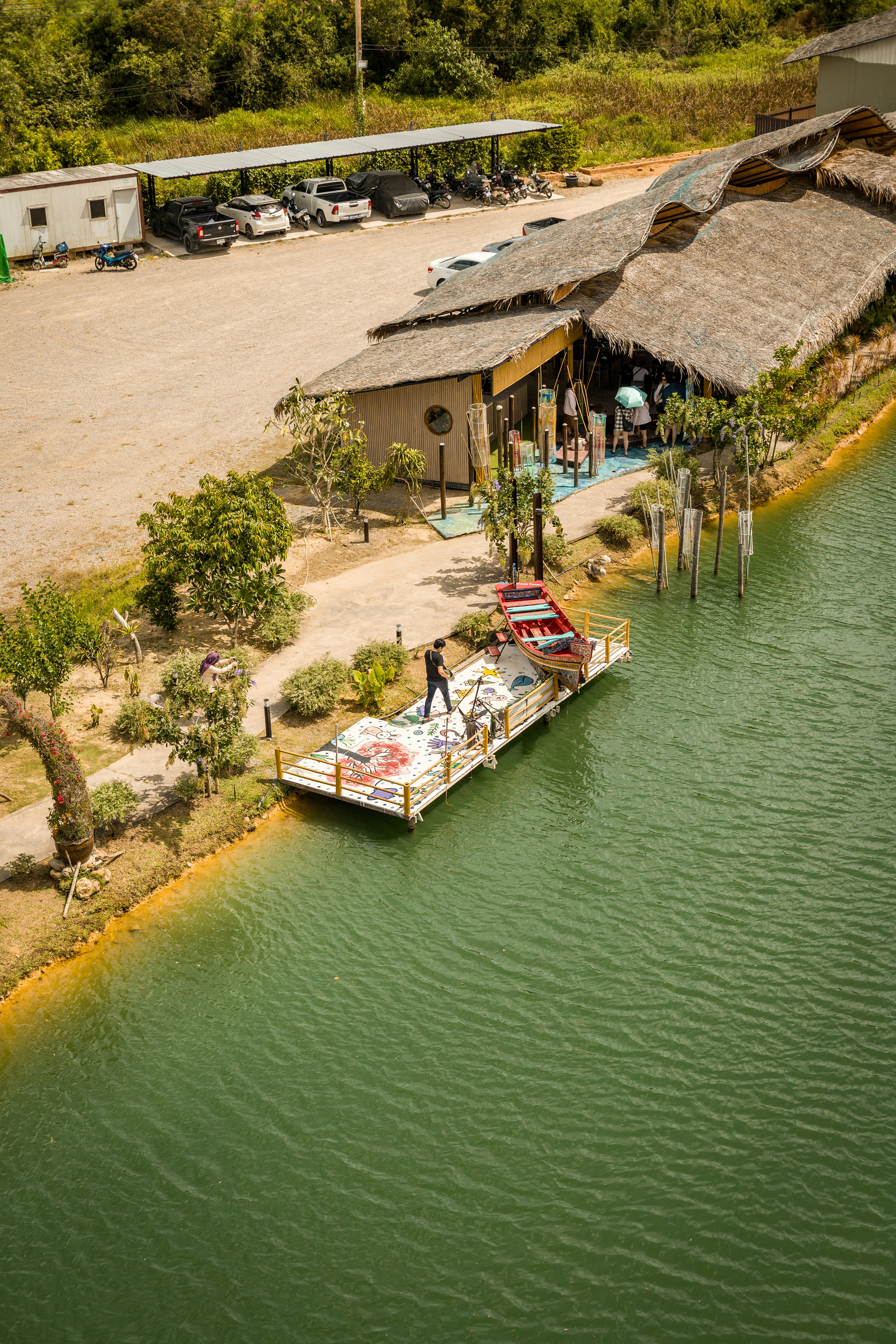 A person stands on a dock beside a lagoon. photo – Free Lake Image on ...