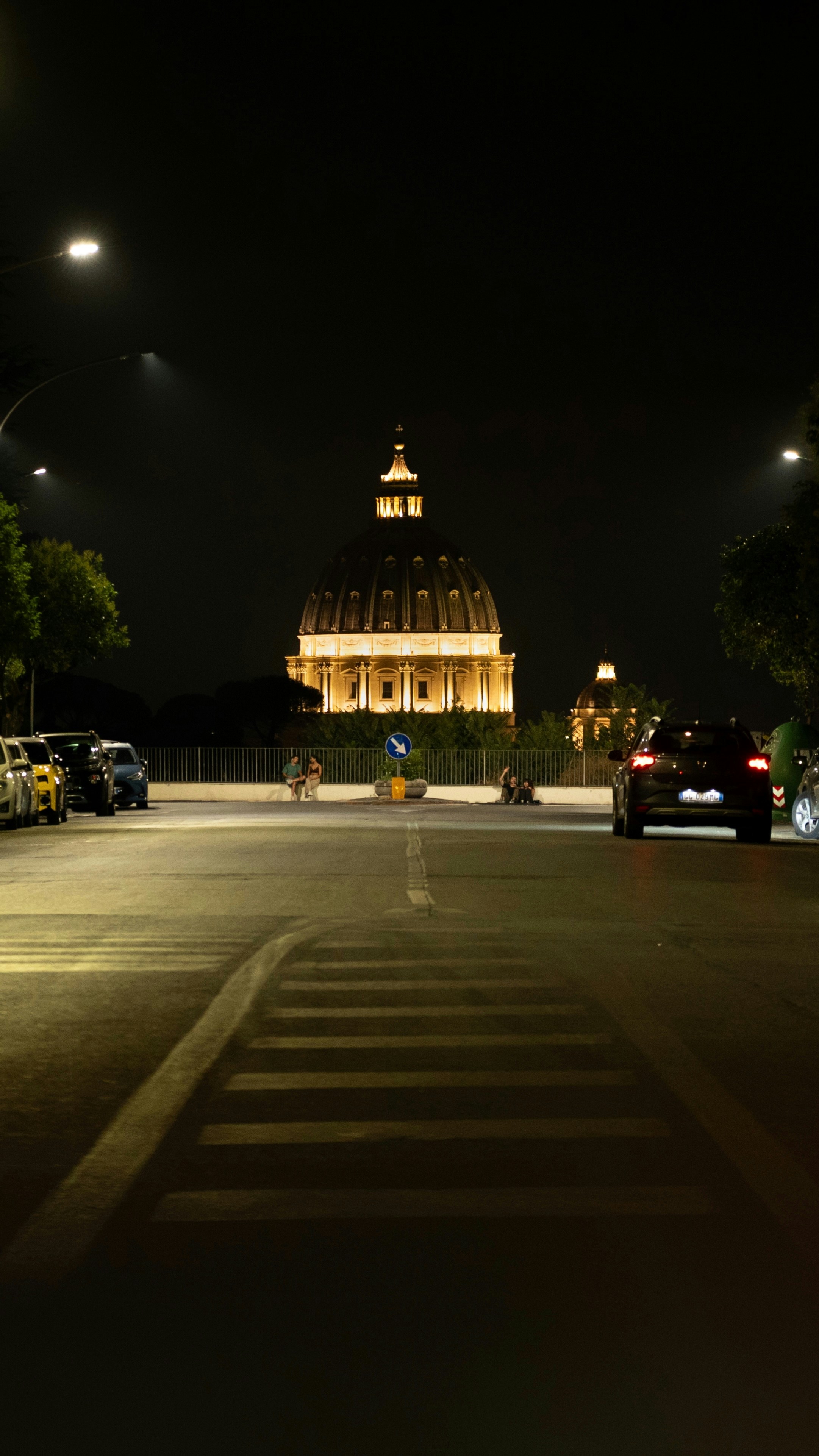 San Pietro, Rome | Night view of a large dome lit up.