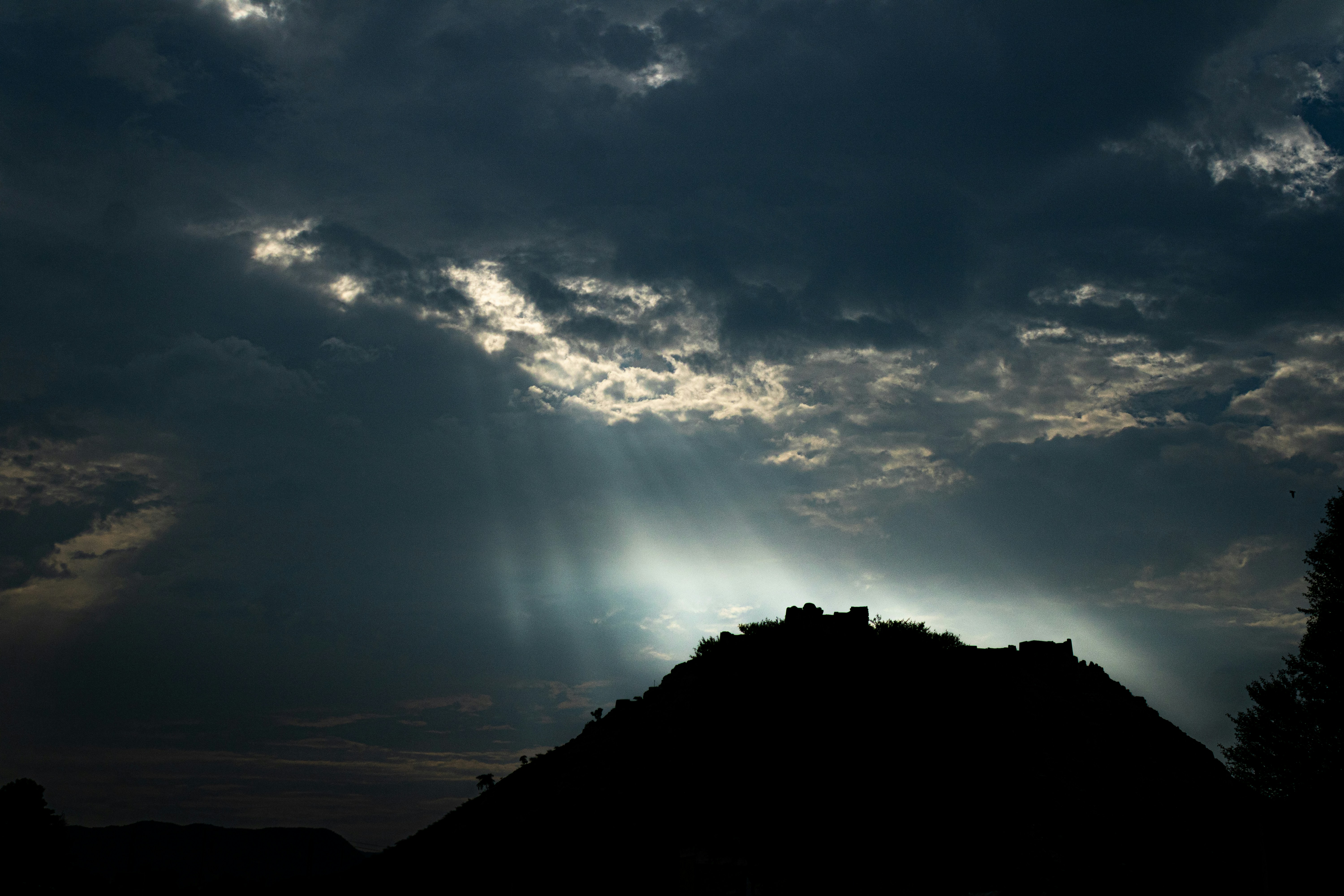 Veil of Light Over Ancient Hills