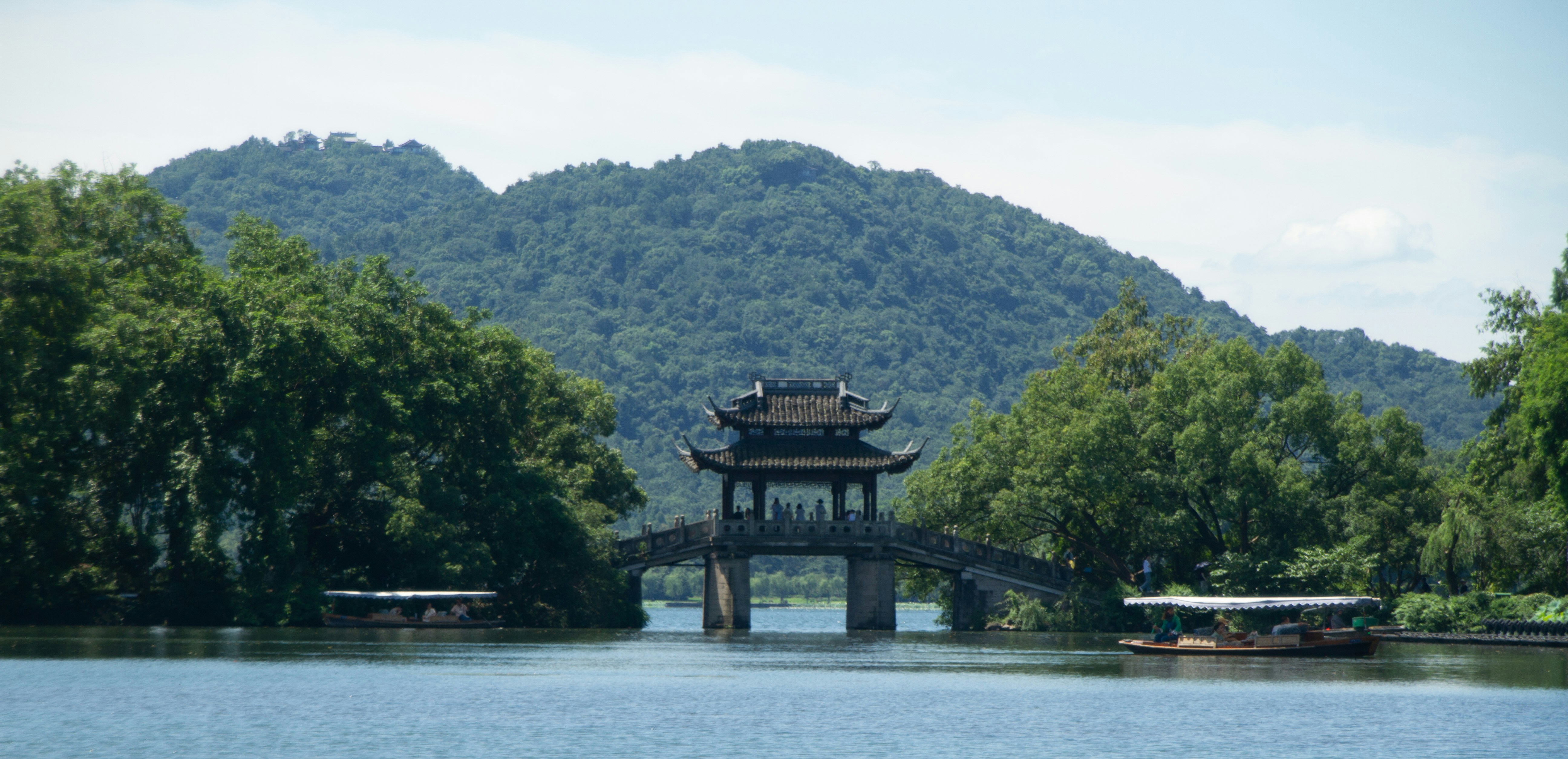 Landscape, somewhere in China. | A chinese bridge is situated over a lake.