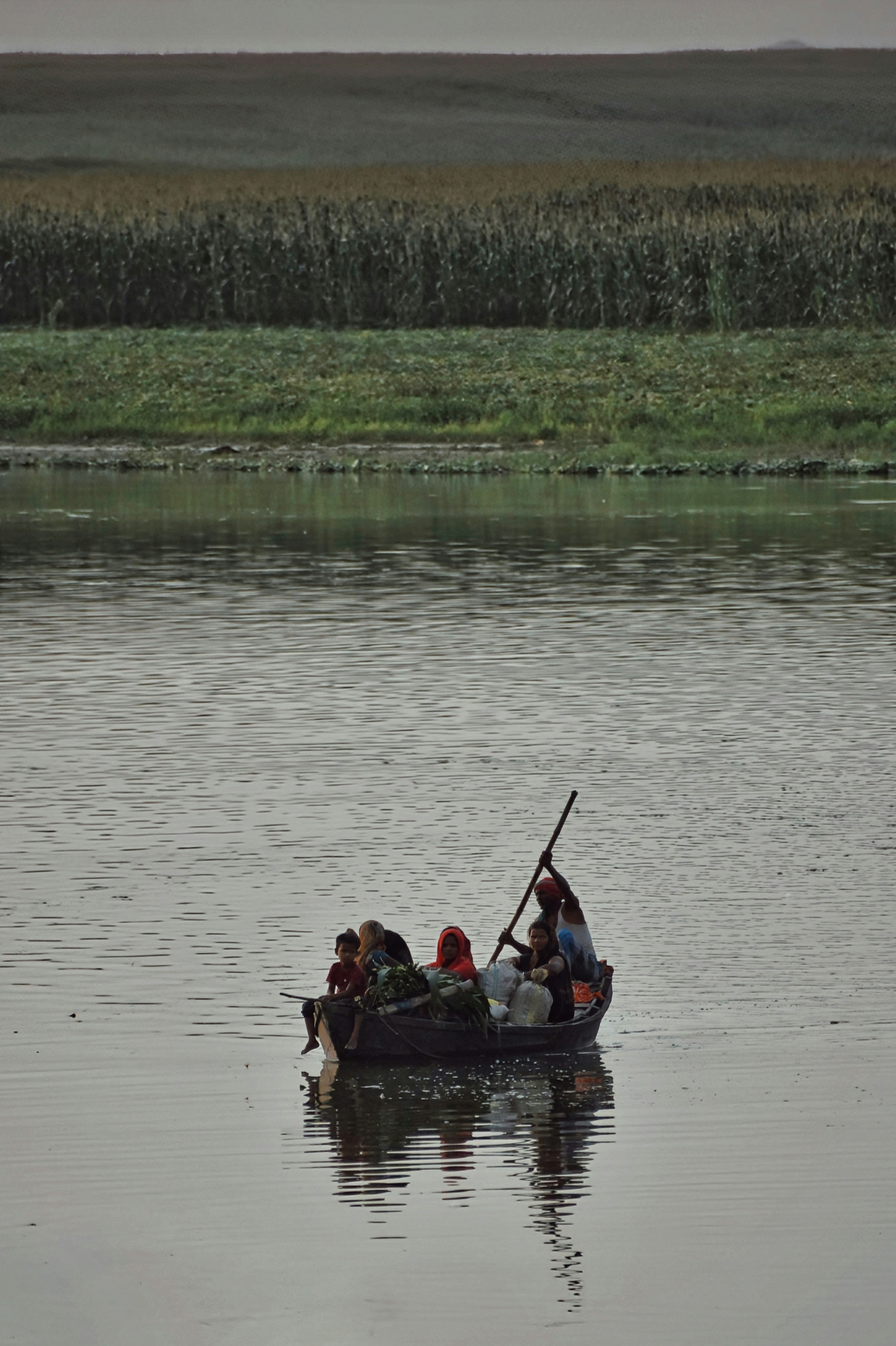 People travel on a boat across the water.