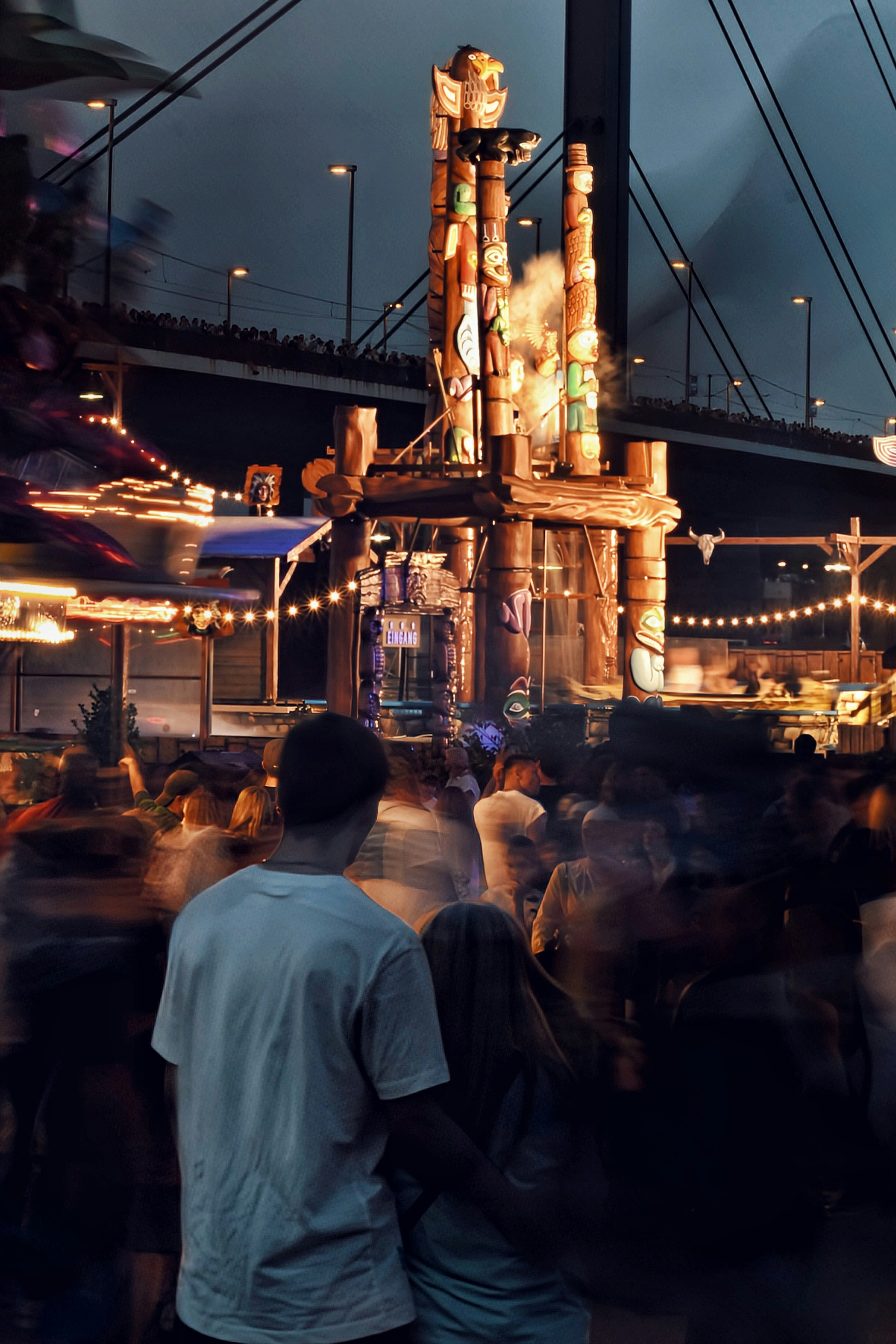 Tiki Tower Under String Lights: A Night Carnival in Motion