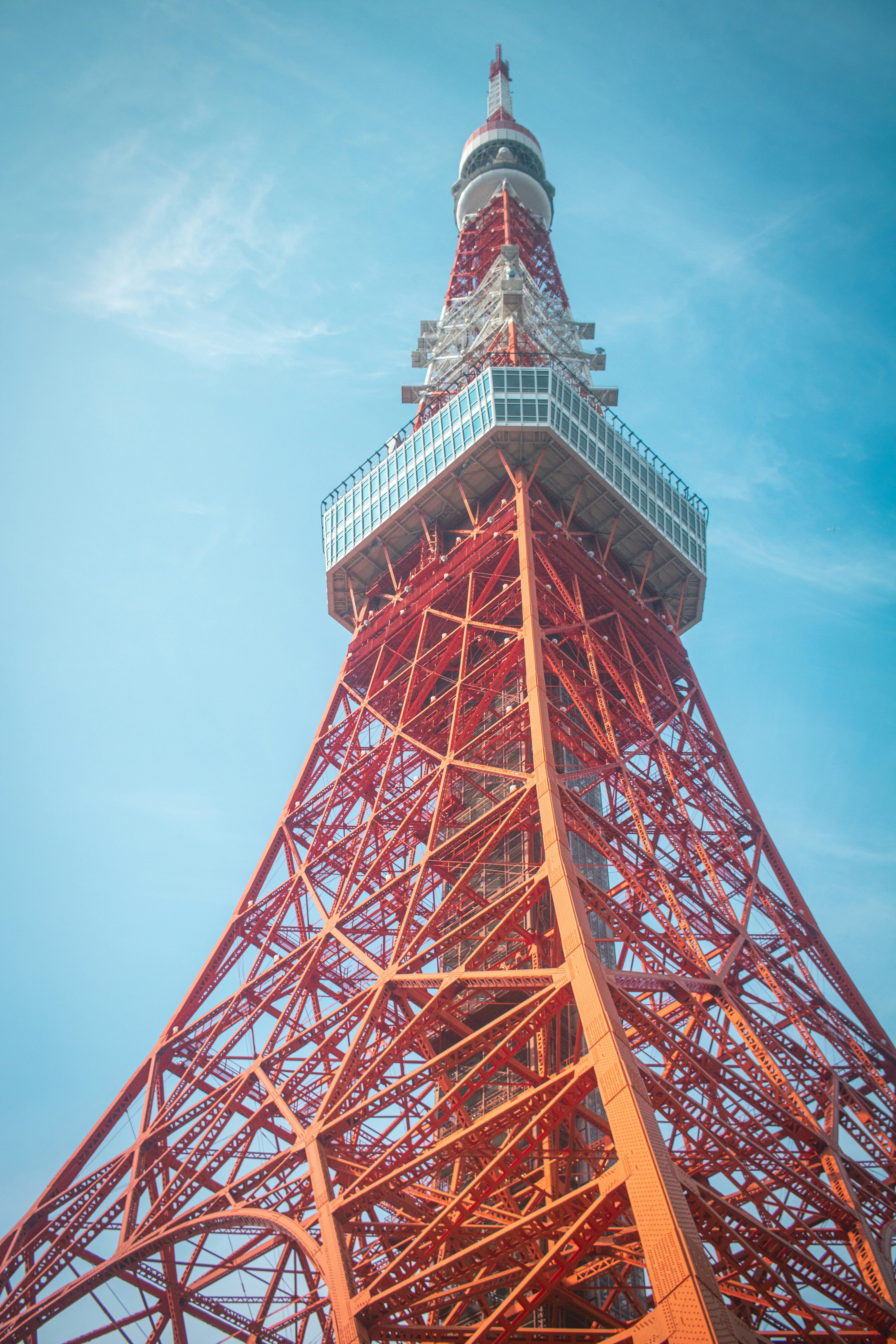 Tokyo tower stands tall against a blue sky.
