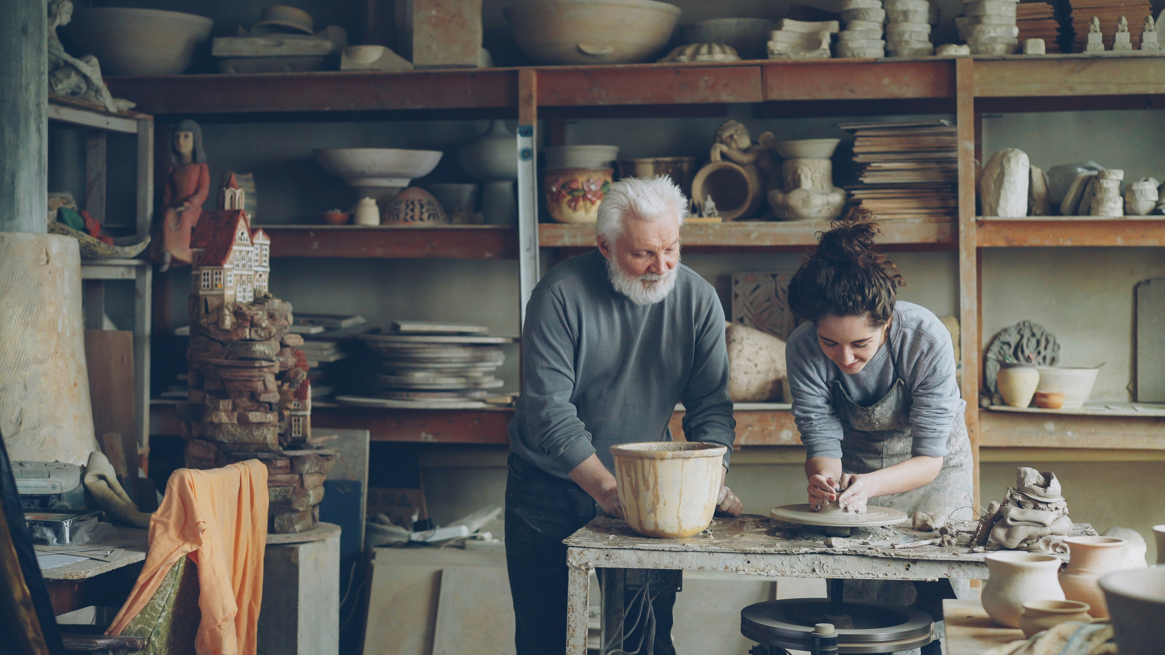 A potter and an apprentice work in a workshop. photo – Free Woman Image ...