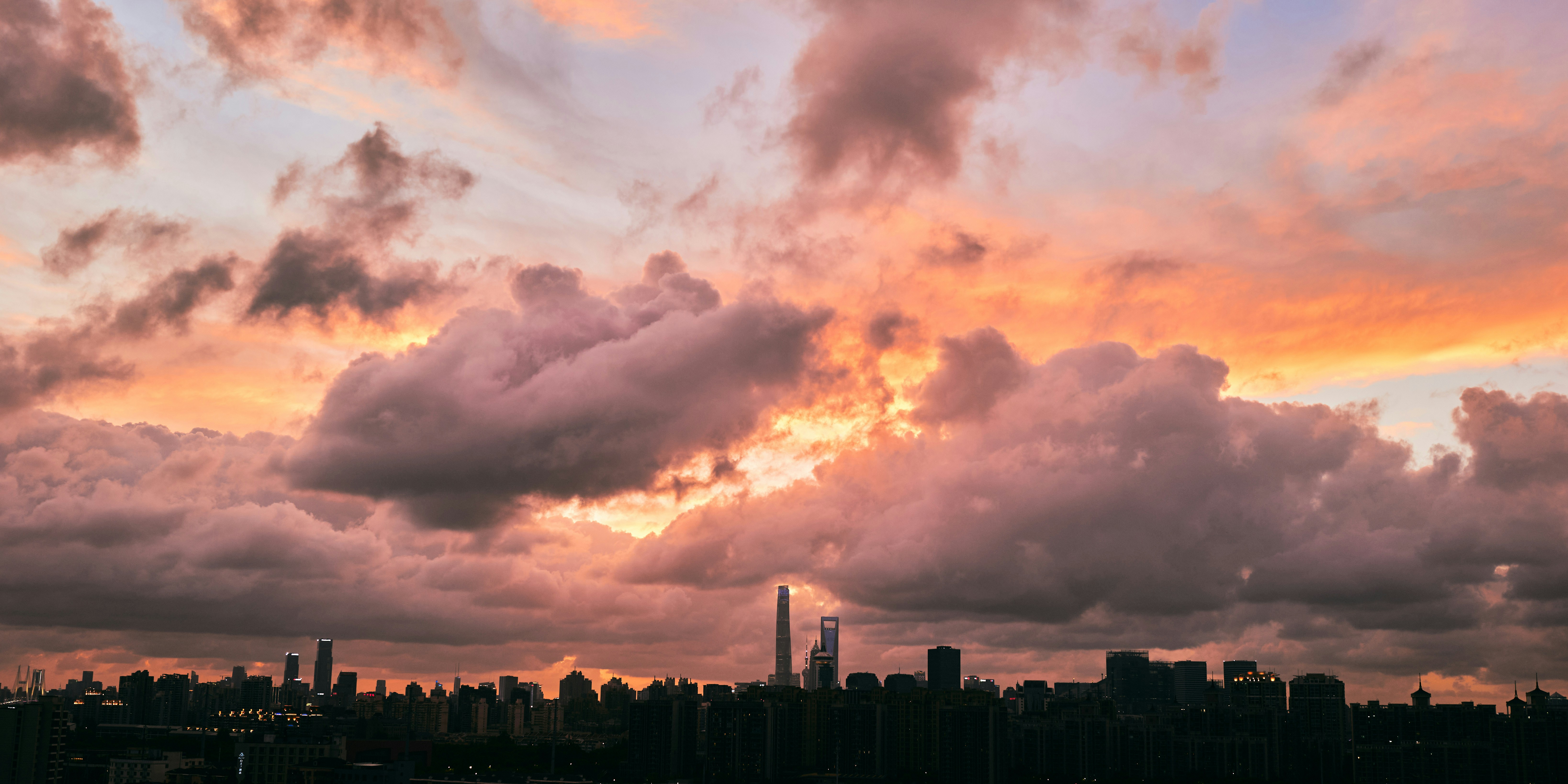 Beautiful sunset over a cityscape with dramatic clouds.