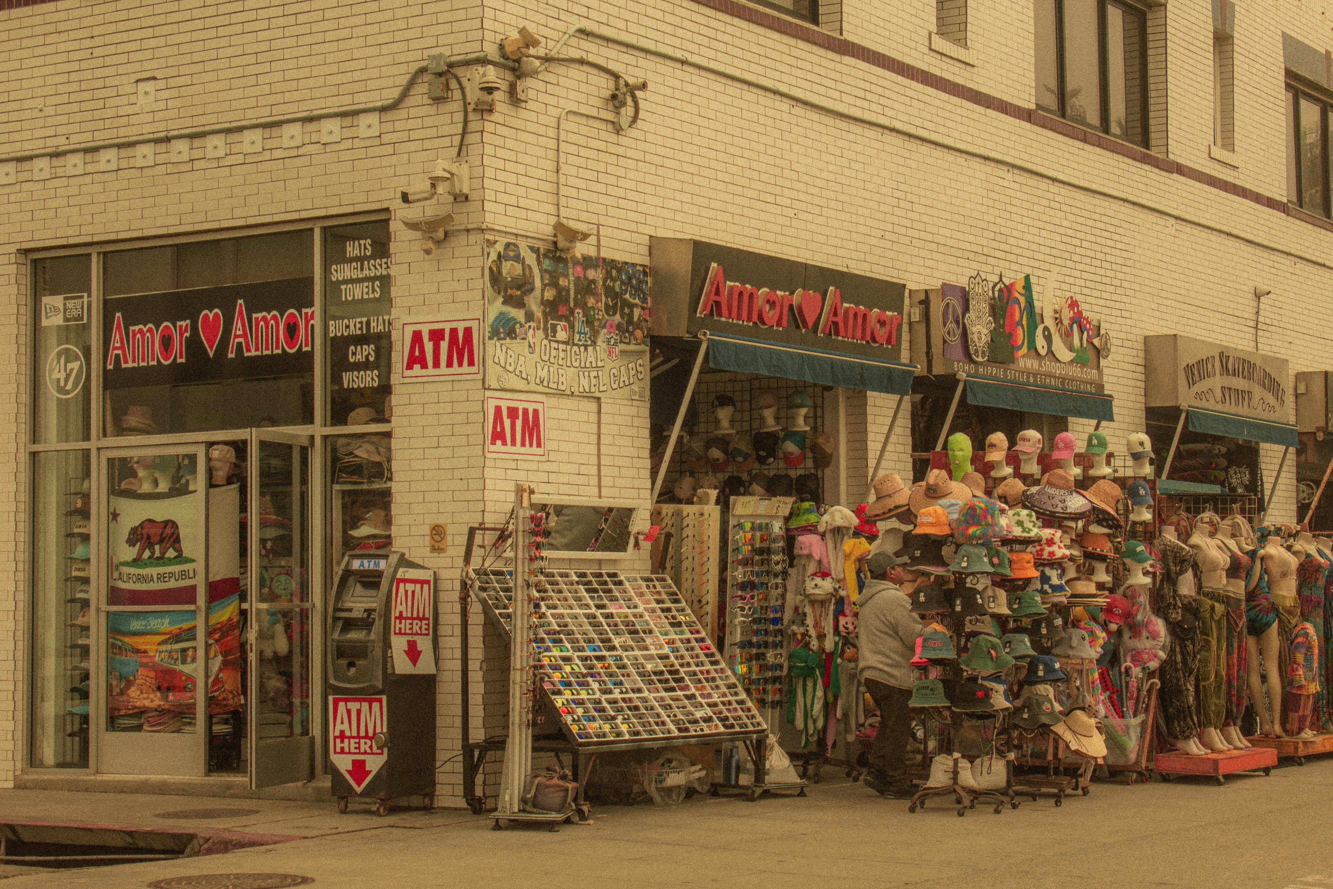 Evening at Venice beach | Souvenir shops line a street corner.