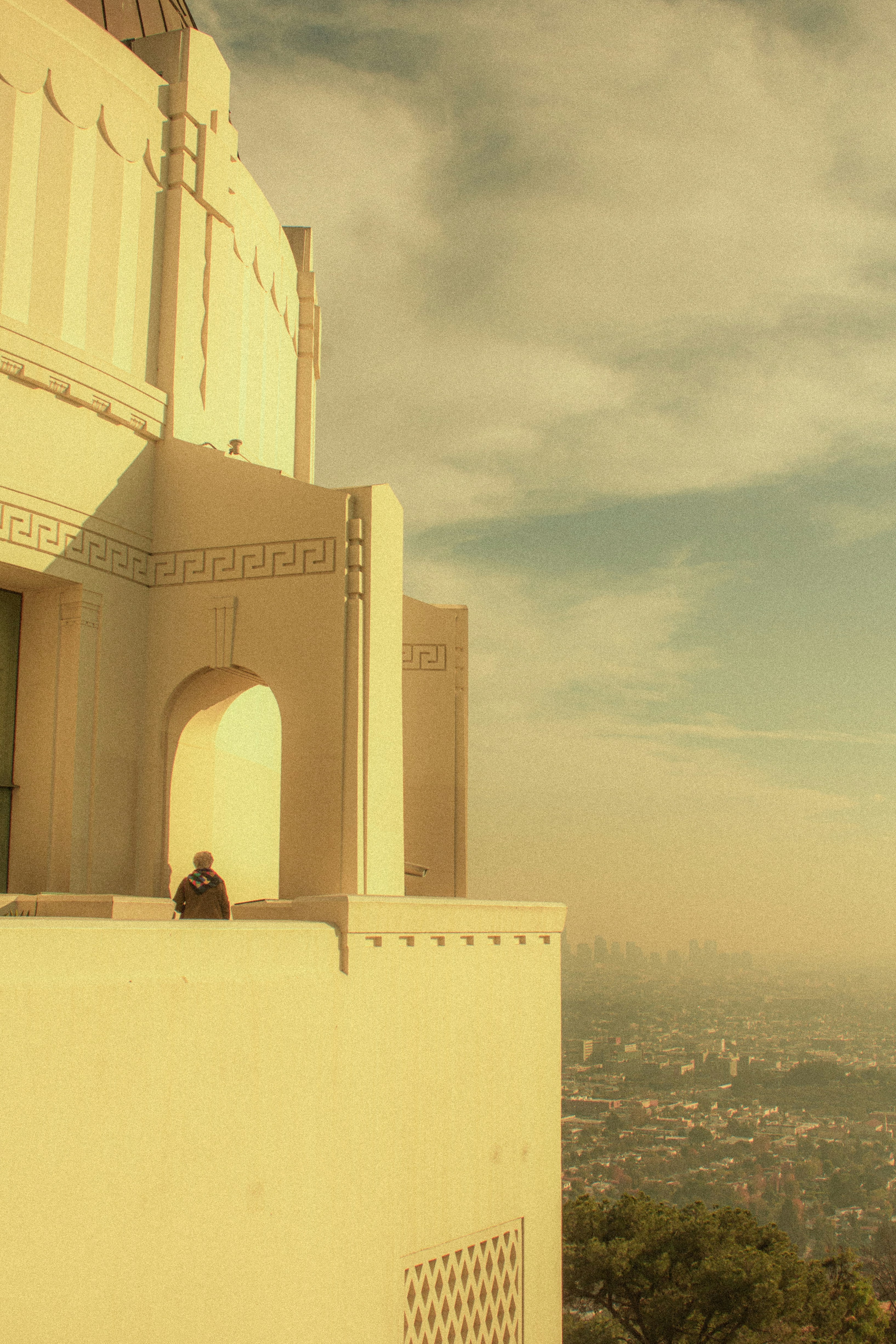 A person admiring the view from a building.