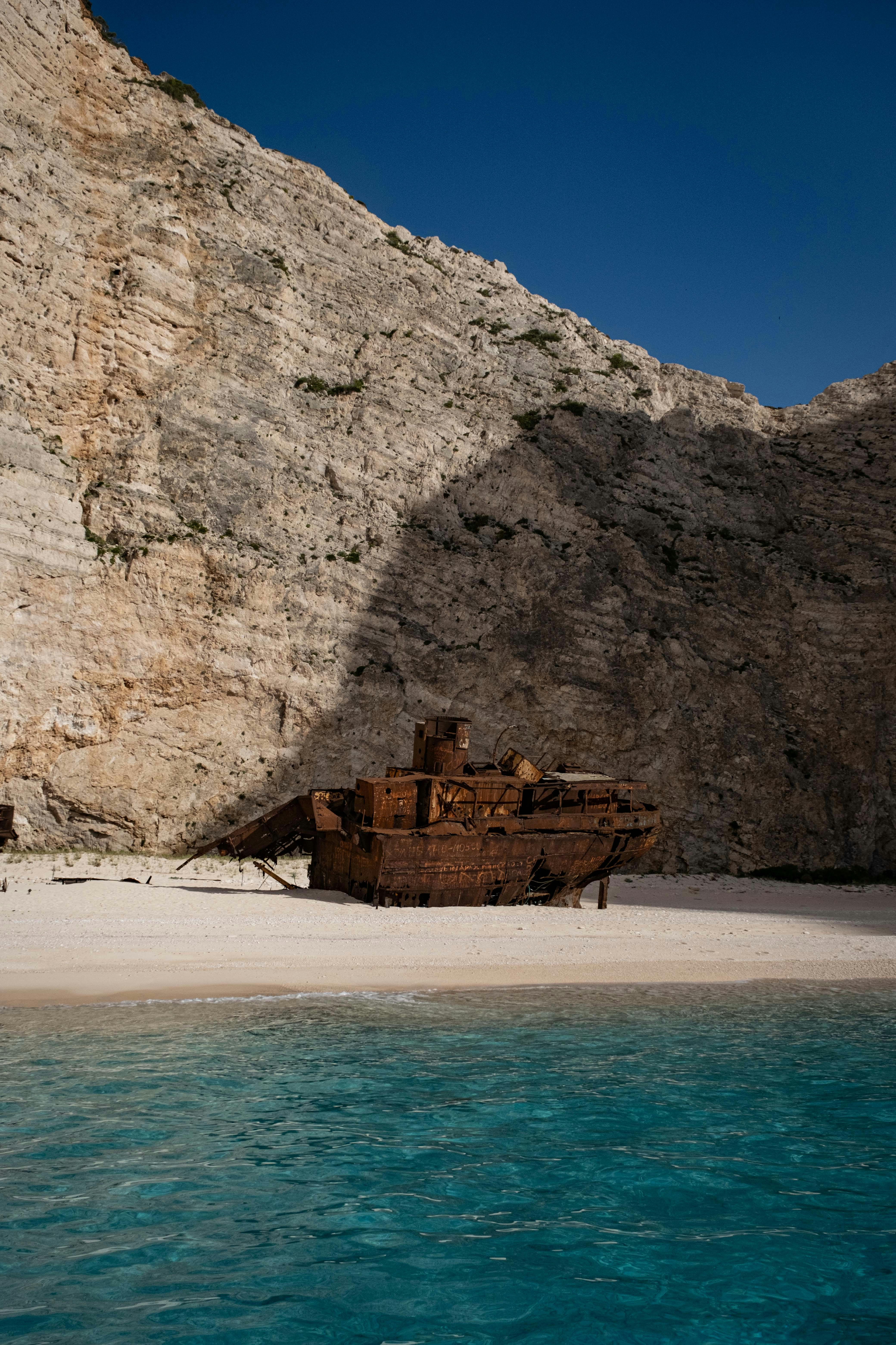 Echoes of the Past: The Rusting Ship on Serene Shores