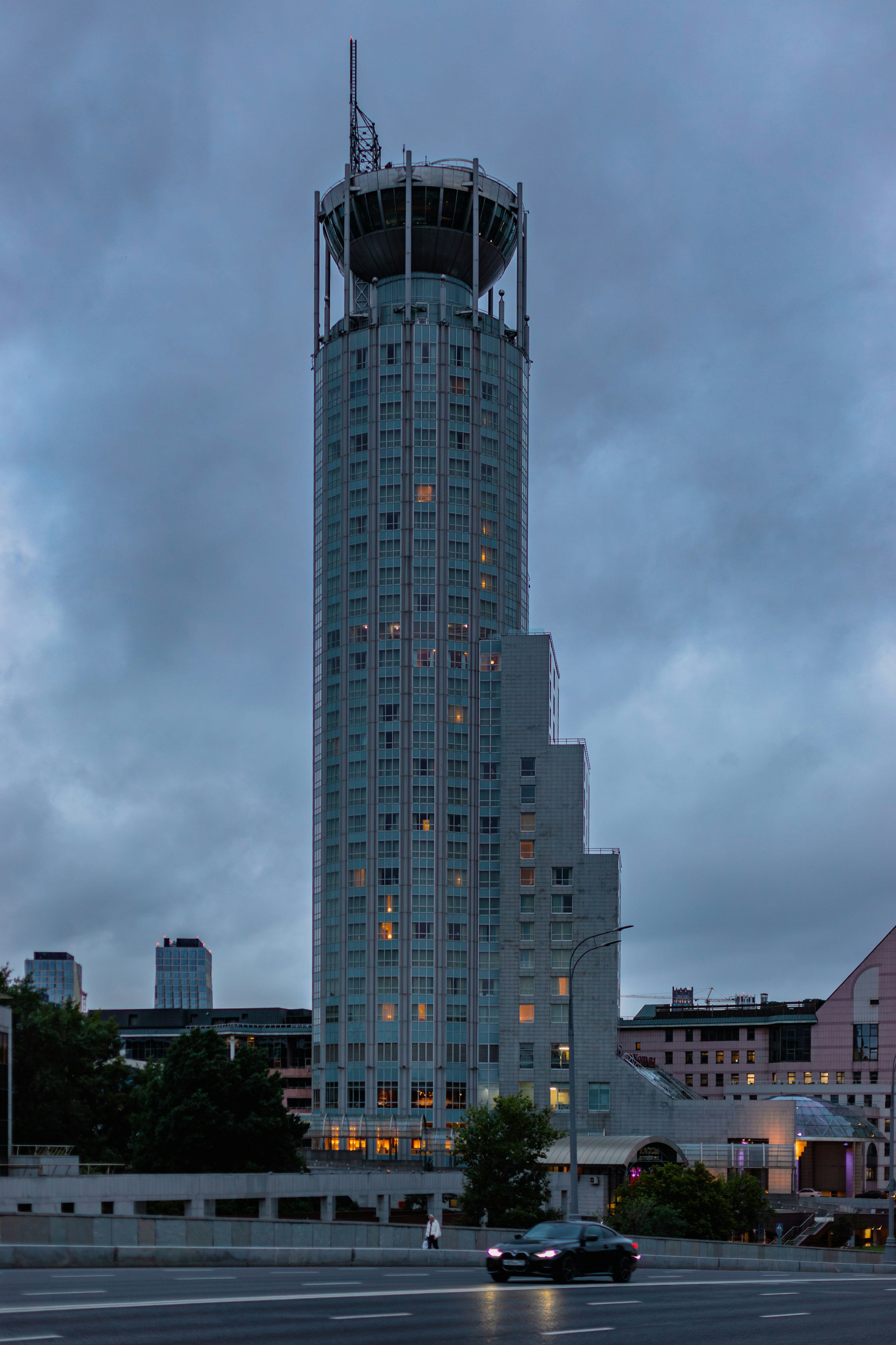 A tall building stands against a cloudy sky.
